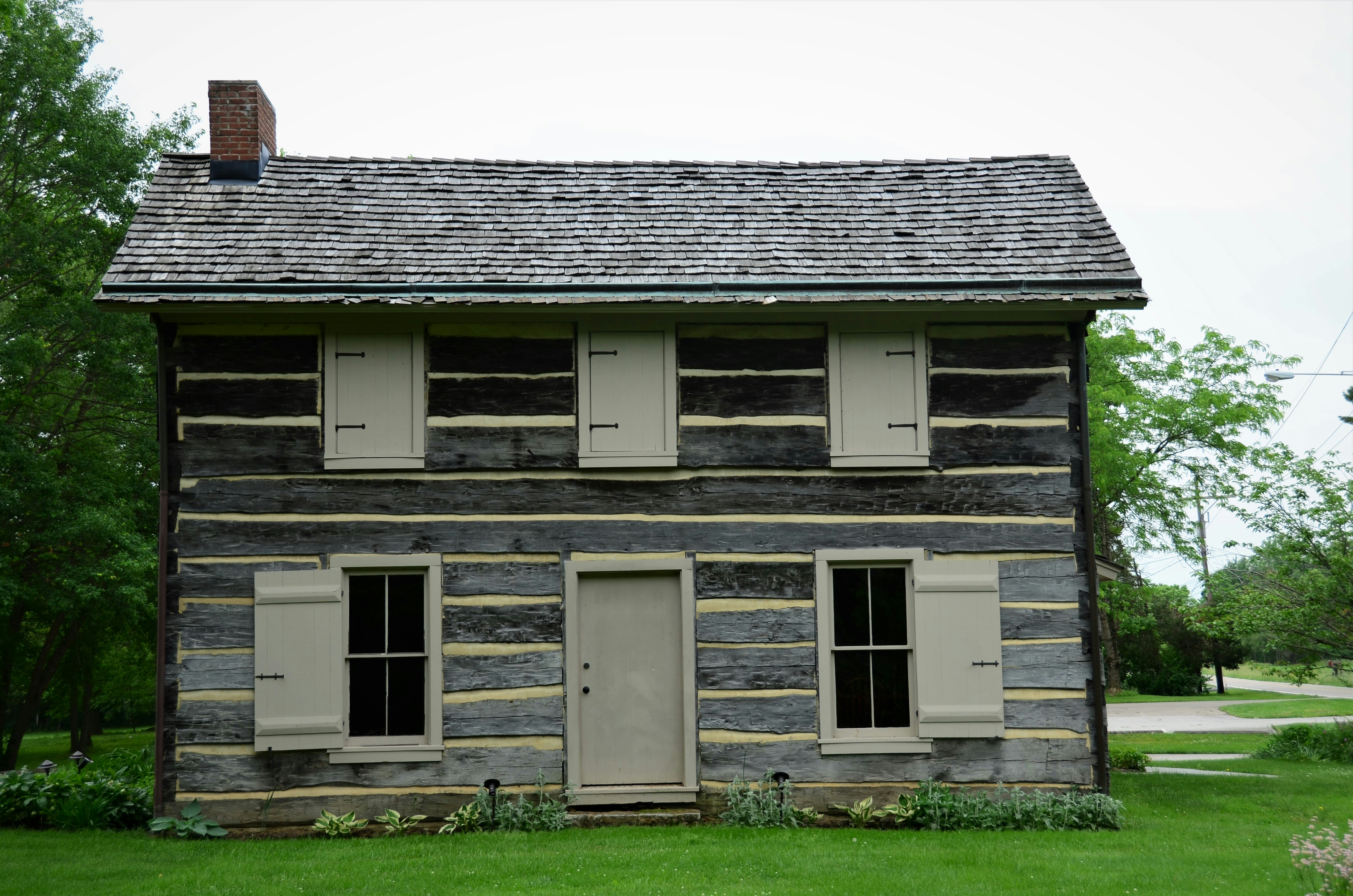 Striped Log Cabin on a Quiet Green Lawn