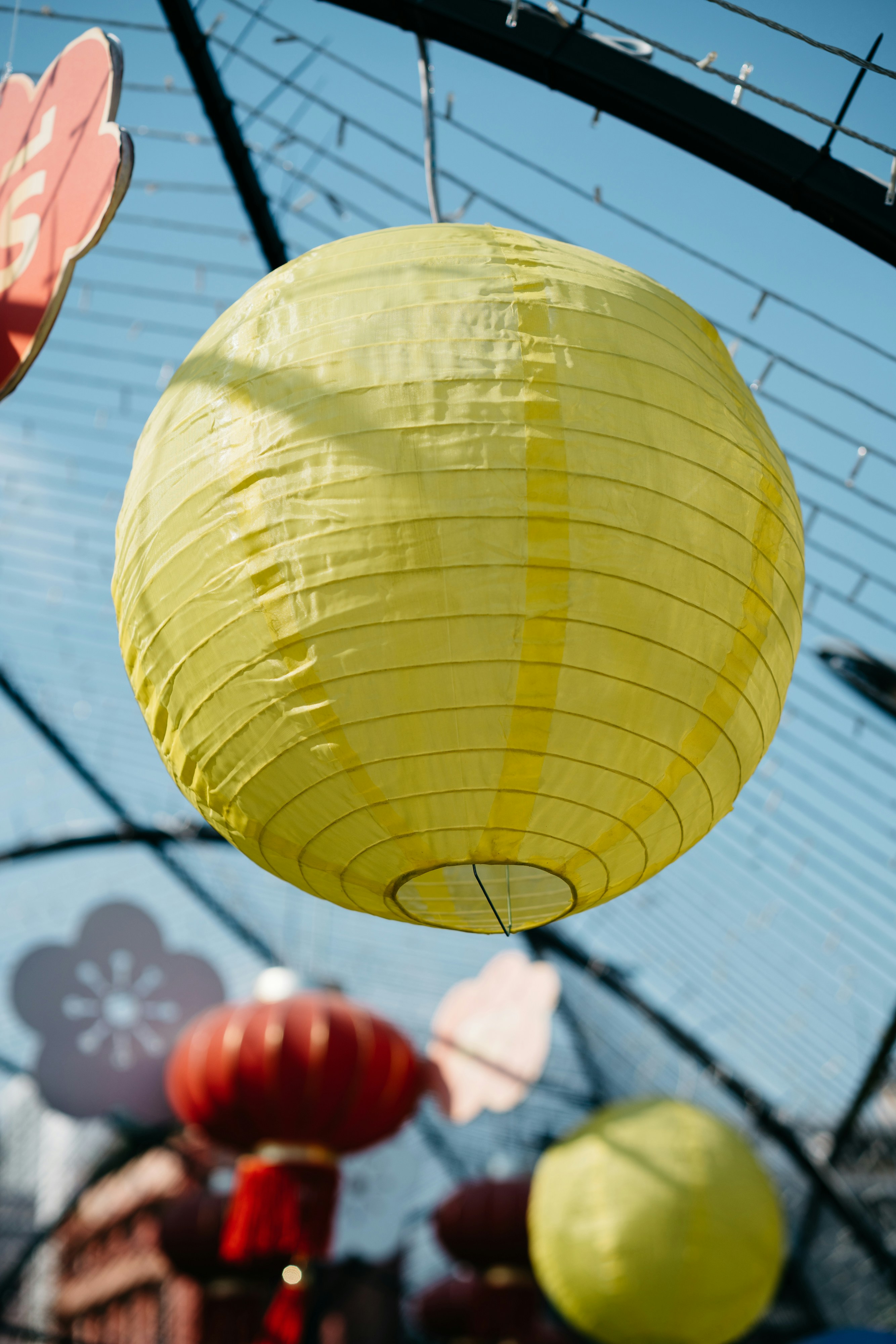 A group of yellow and red lanterns hanging from a ceiling photo – Free ...