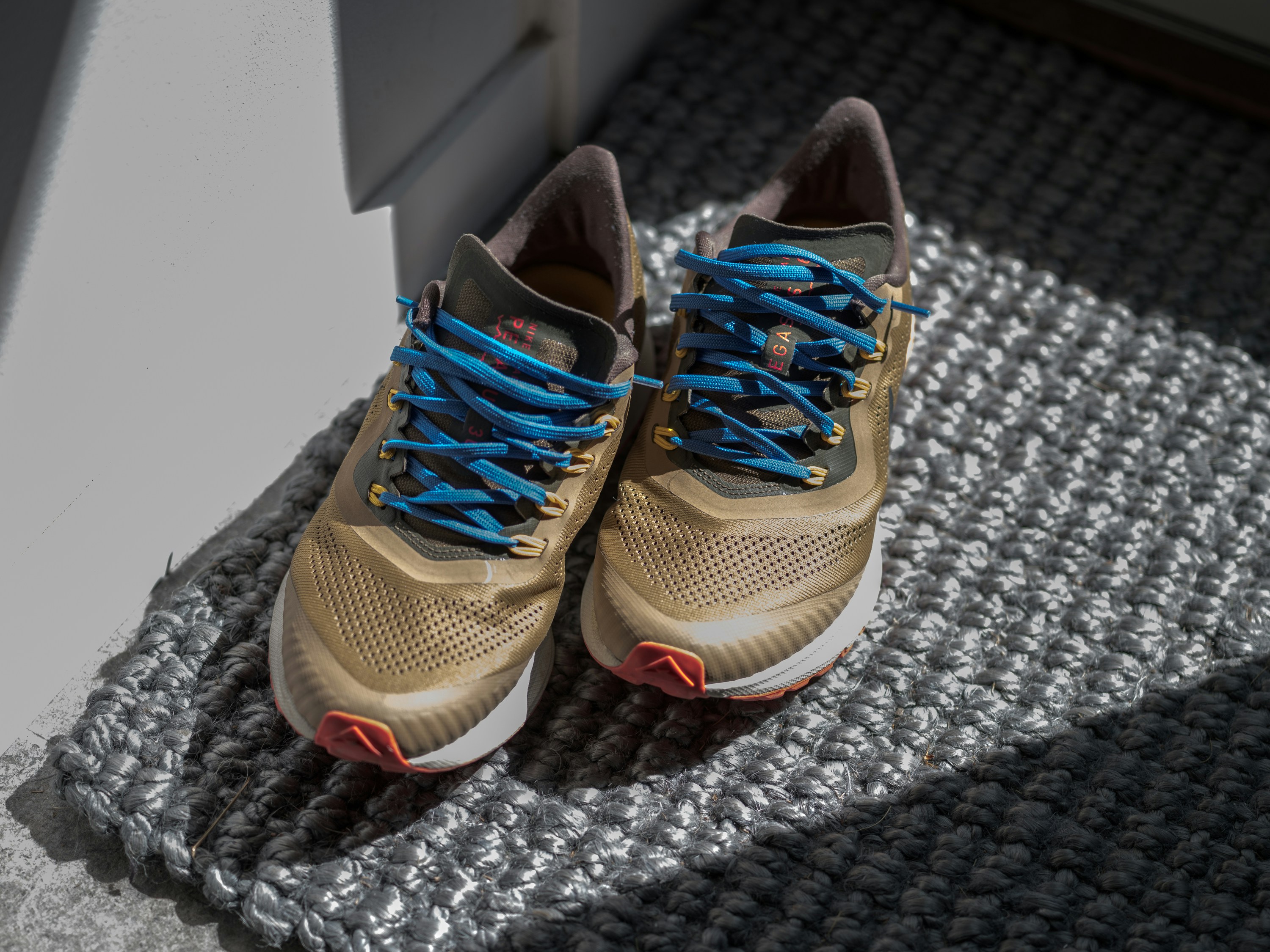 A pair of shoes with blue laces on them photo – Free Shoe Image on Unsplash