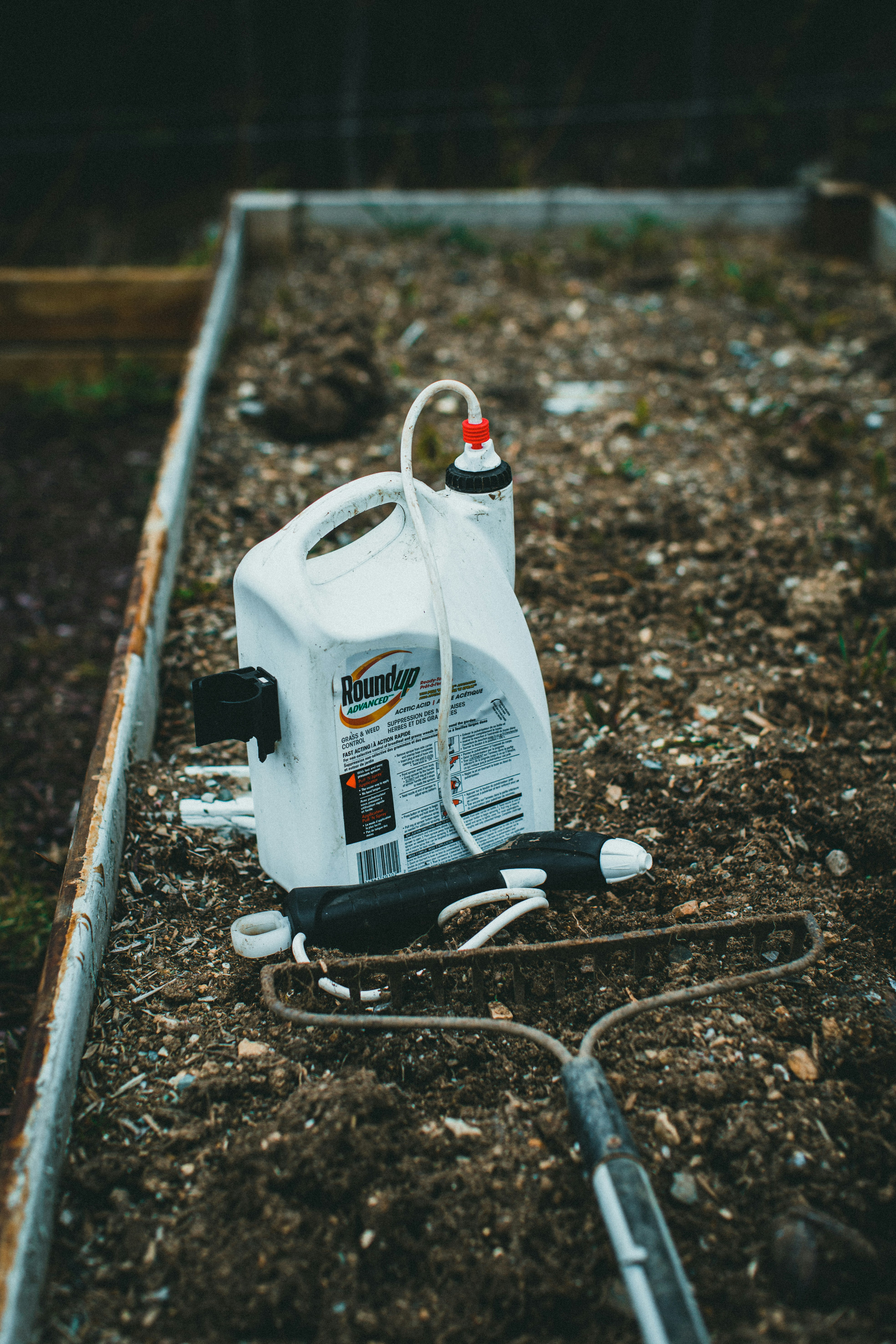 A gallon of liquid sitting on top of a dirt field photo – Free Grey ...