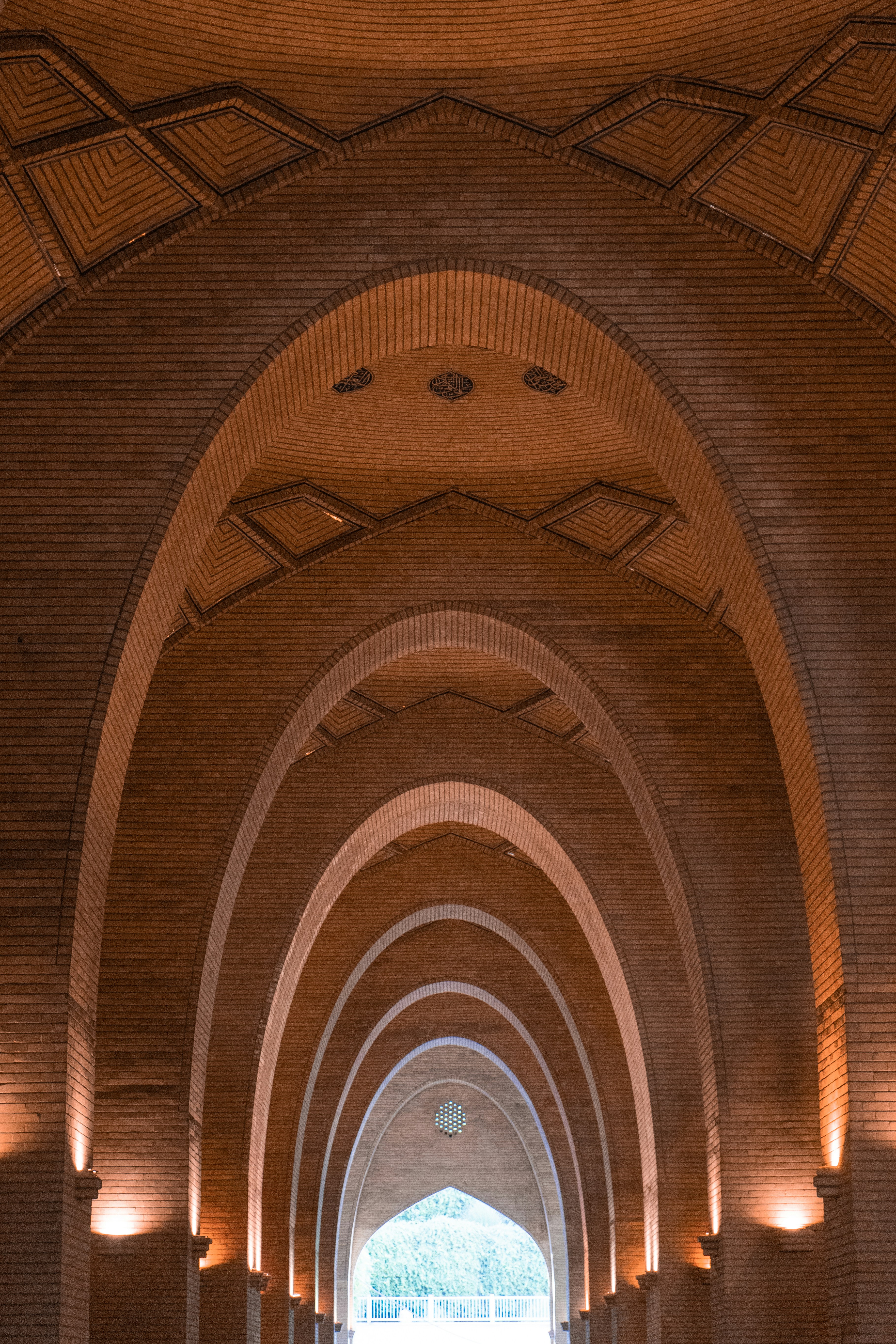 Symmetry in Stone: Lantern-lit Archway Corridor