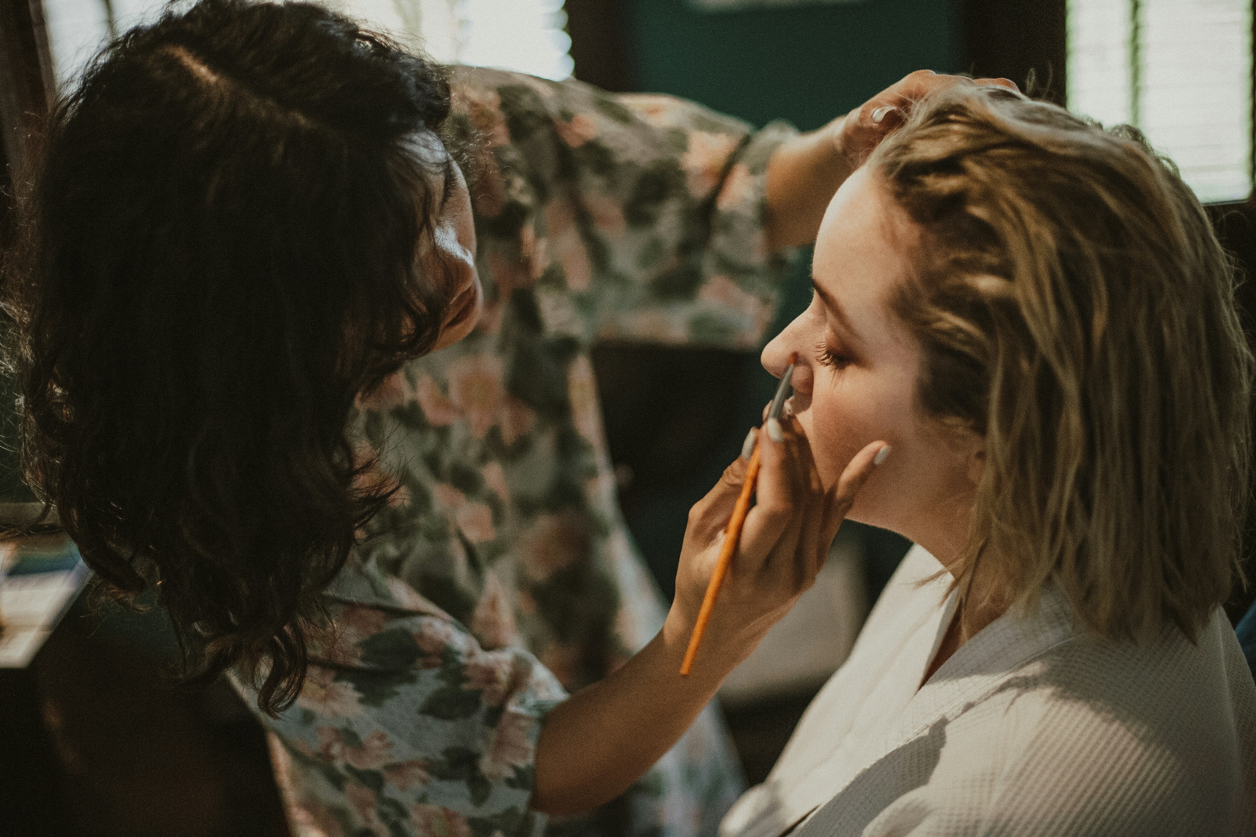 A woman brushing her teeth while another woman looks on photo – Free ...
