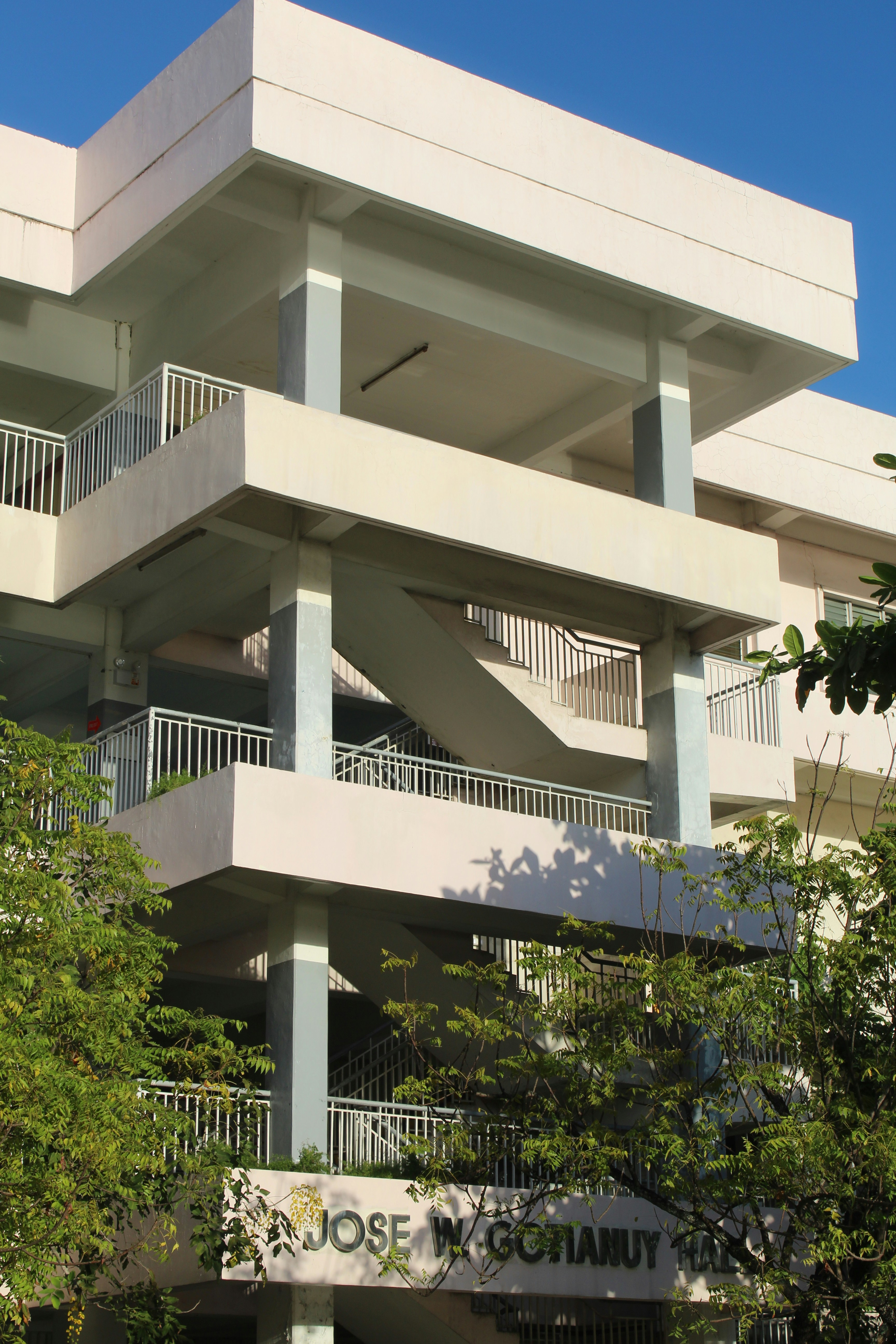 A tall white building with balconies and balconies photo – Free Uc metc ...