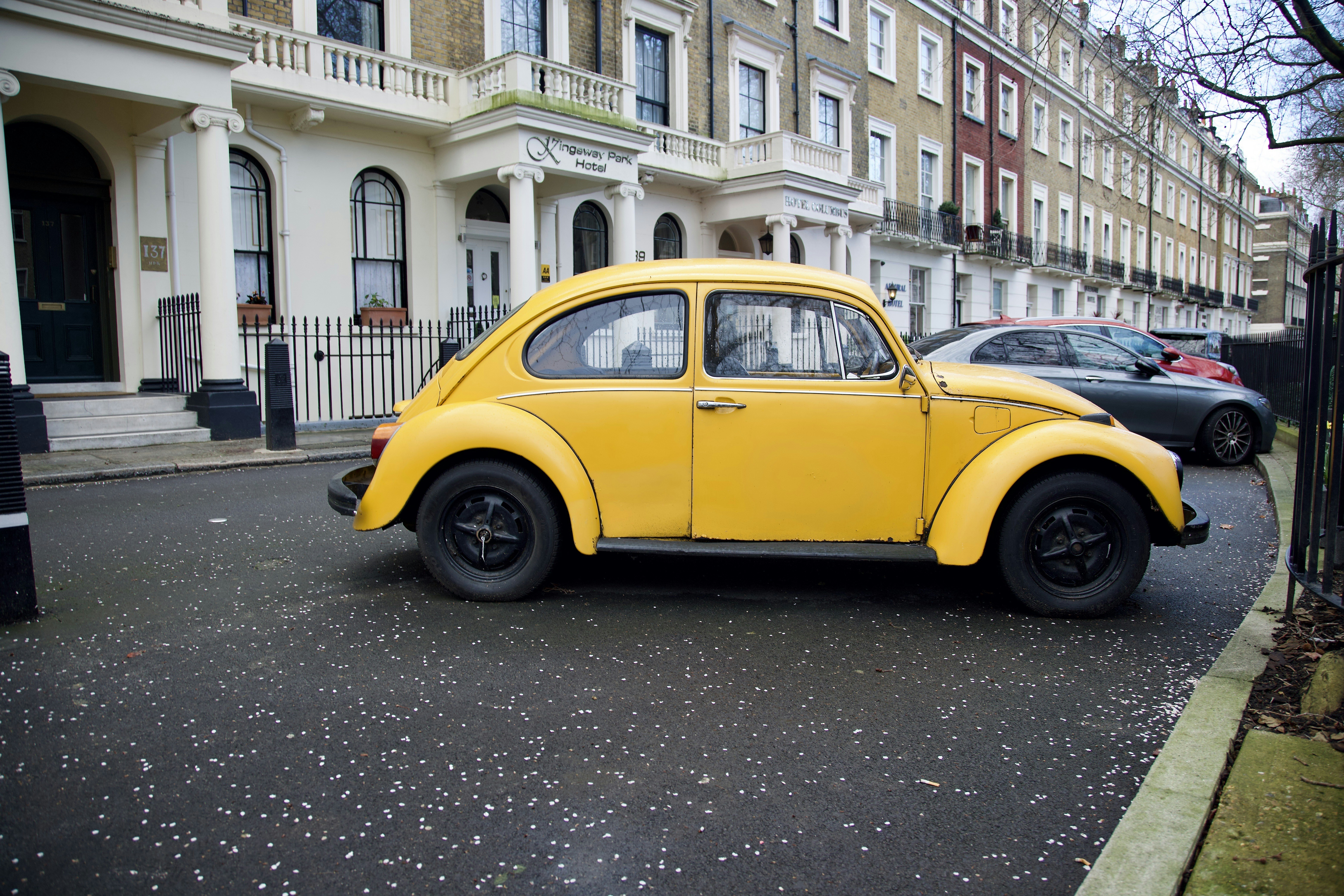Sunlit VW Beetle Anchored by a Row of Georgian Townhouses