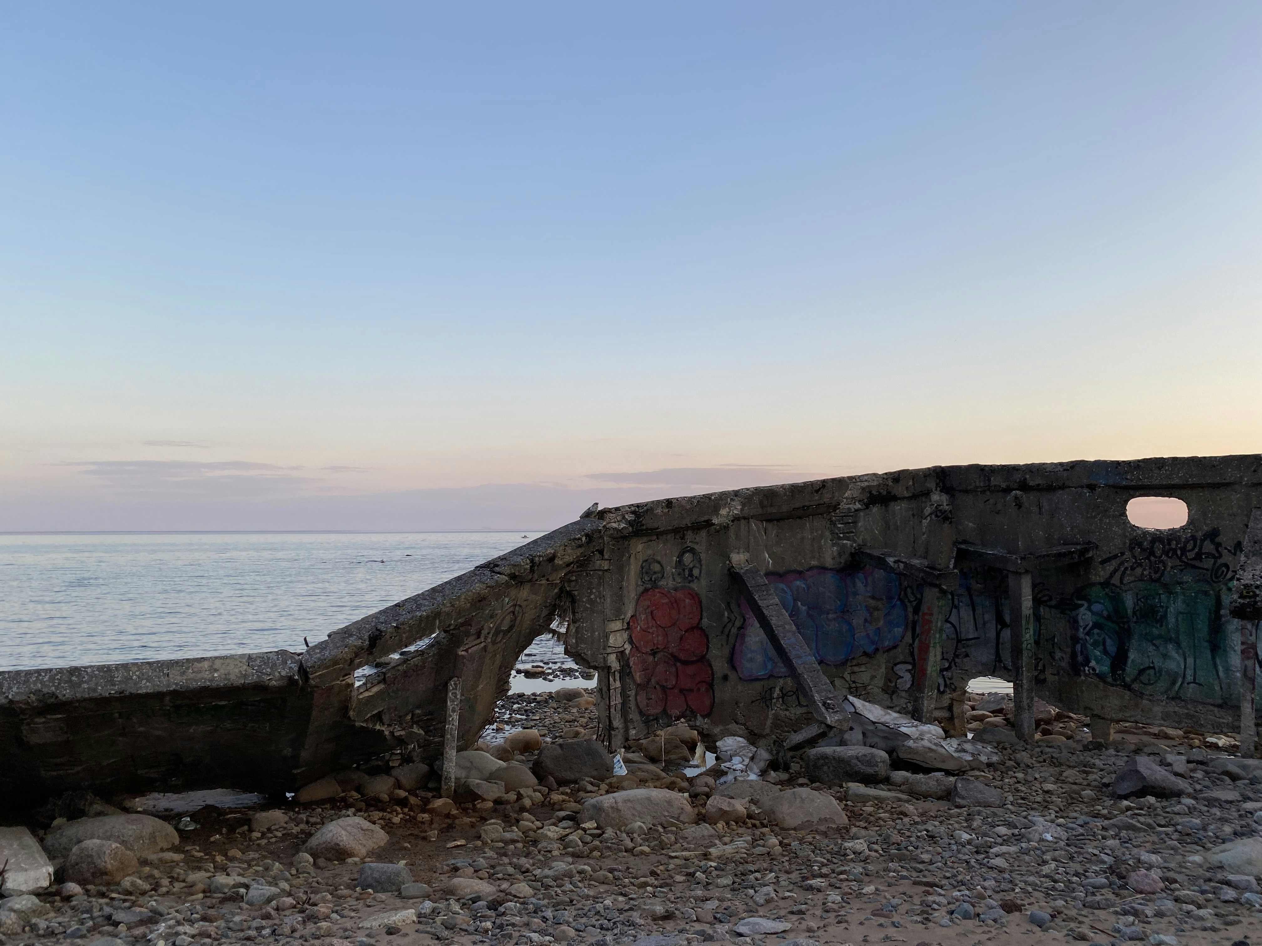 Rusted Breakwater Beneath a Quiet Horizon