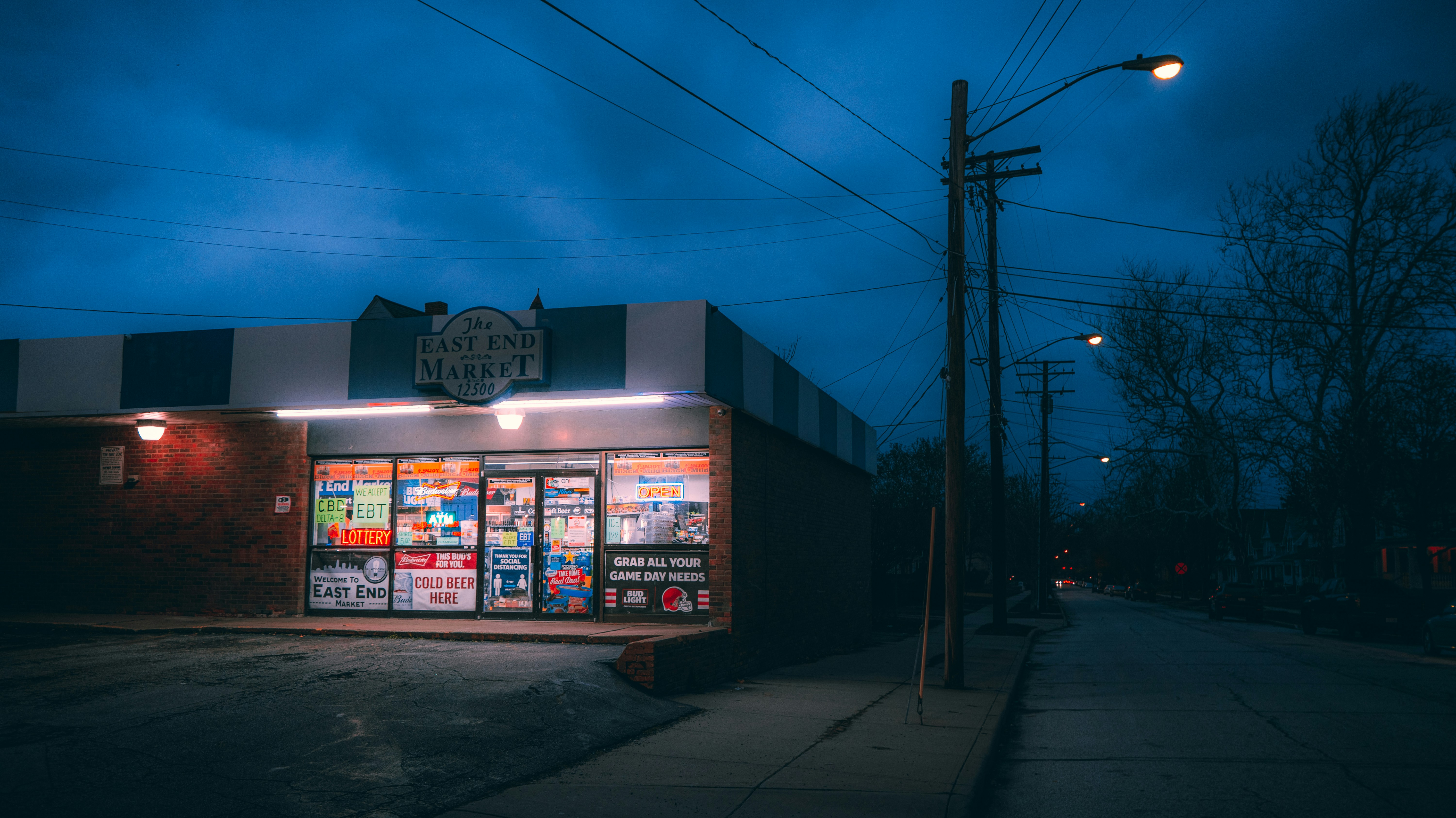 Nocturnal Glow: Urban Storefront's Quiet LuminanceRaymond Kotewicz