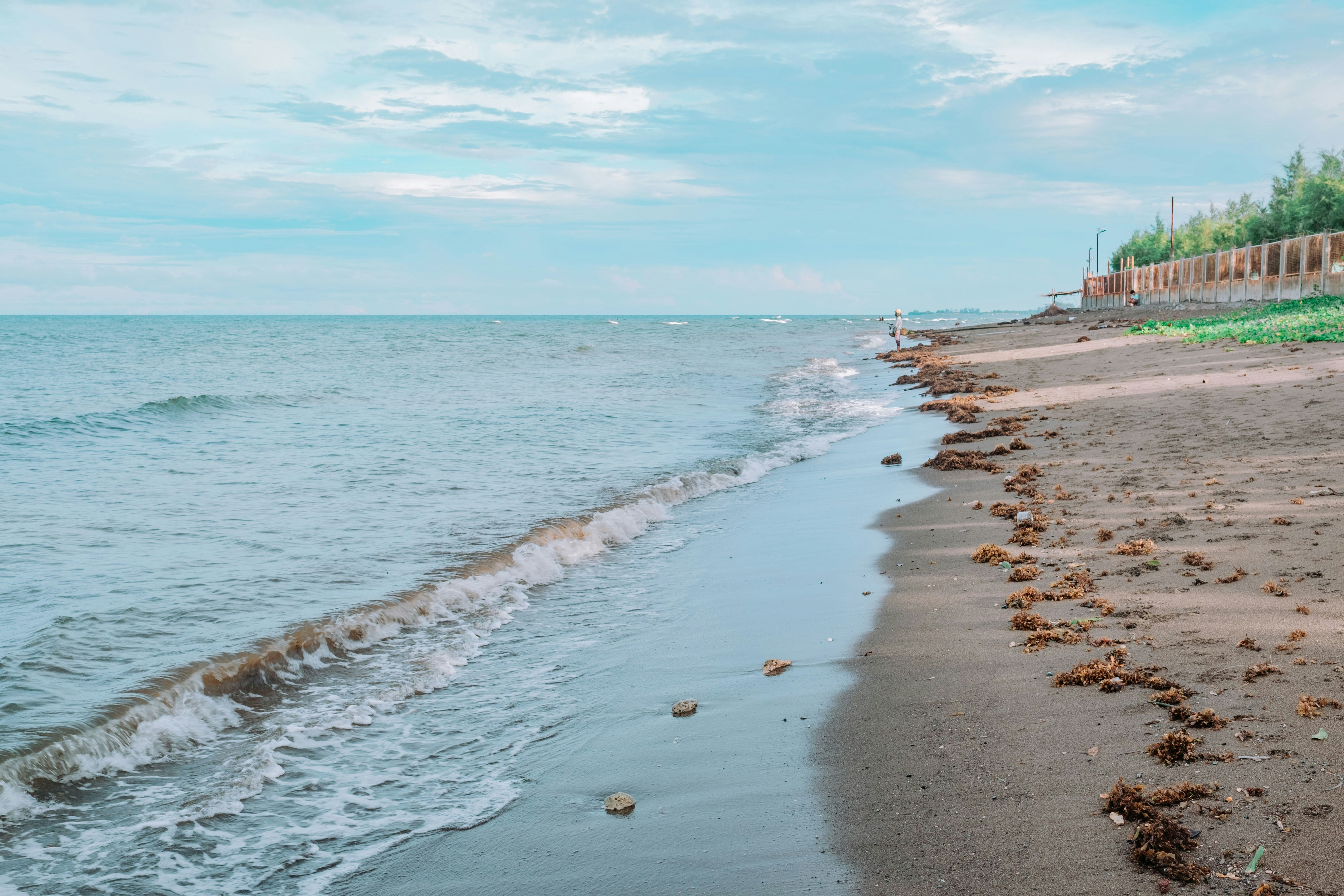 a sandy beach with waves coming in to shore