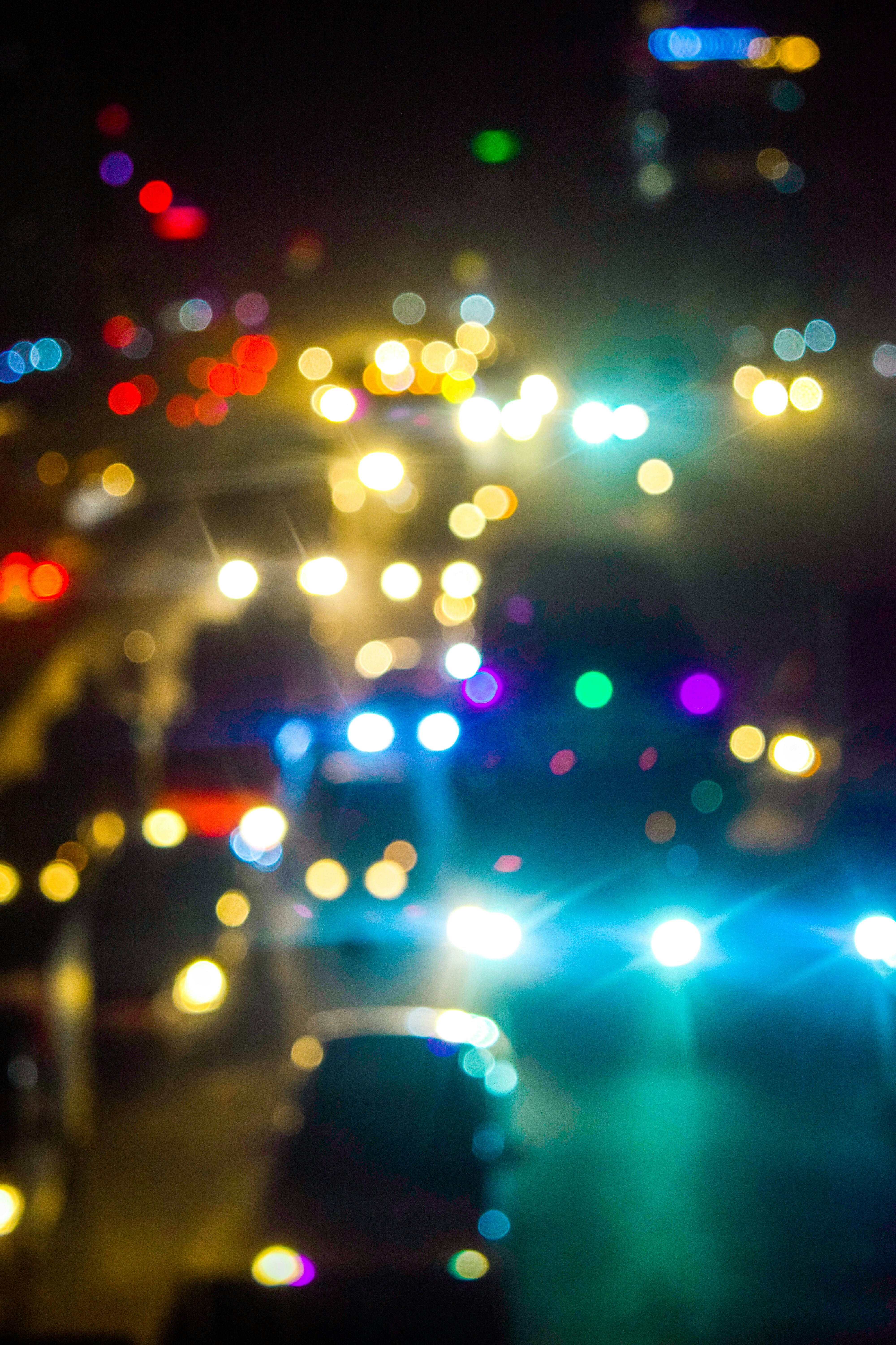 A blurry photo of a city street at night photo – Free Night light Image ...