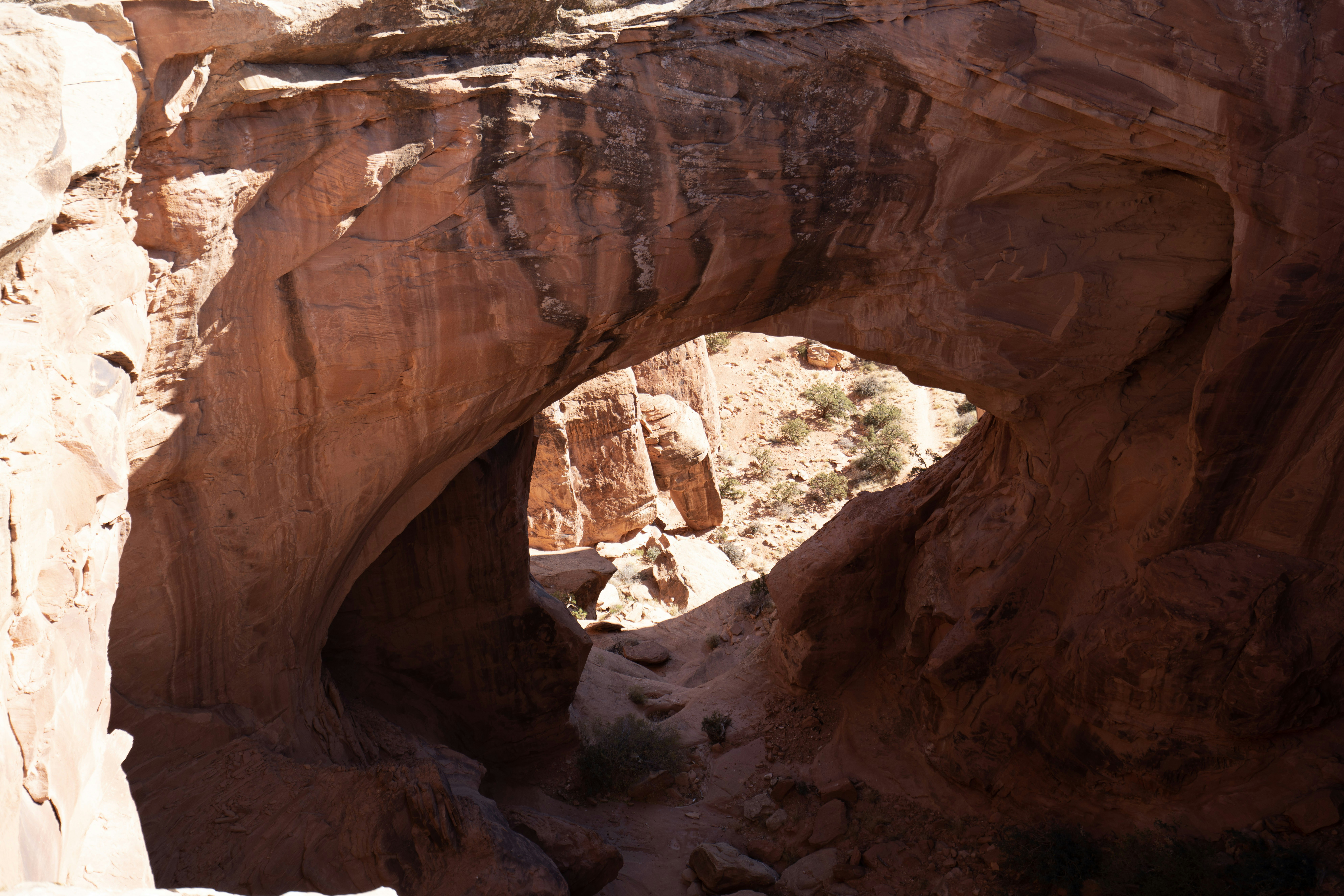 A large arch in the side of a mountain photo – Free Gemini bridges road ...