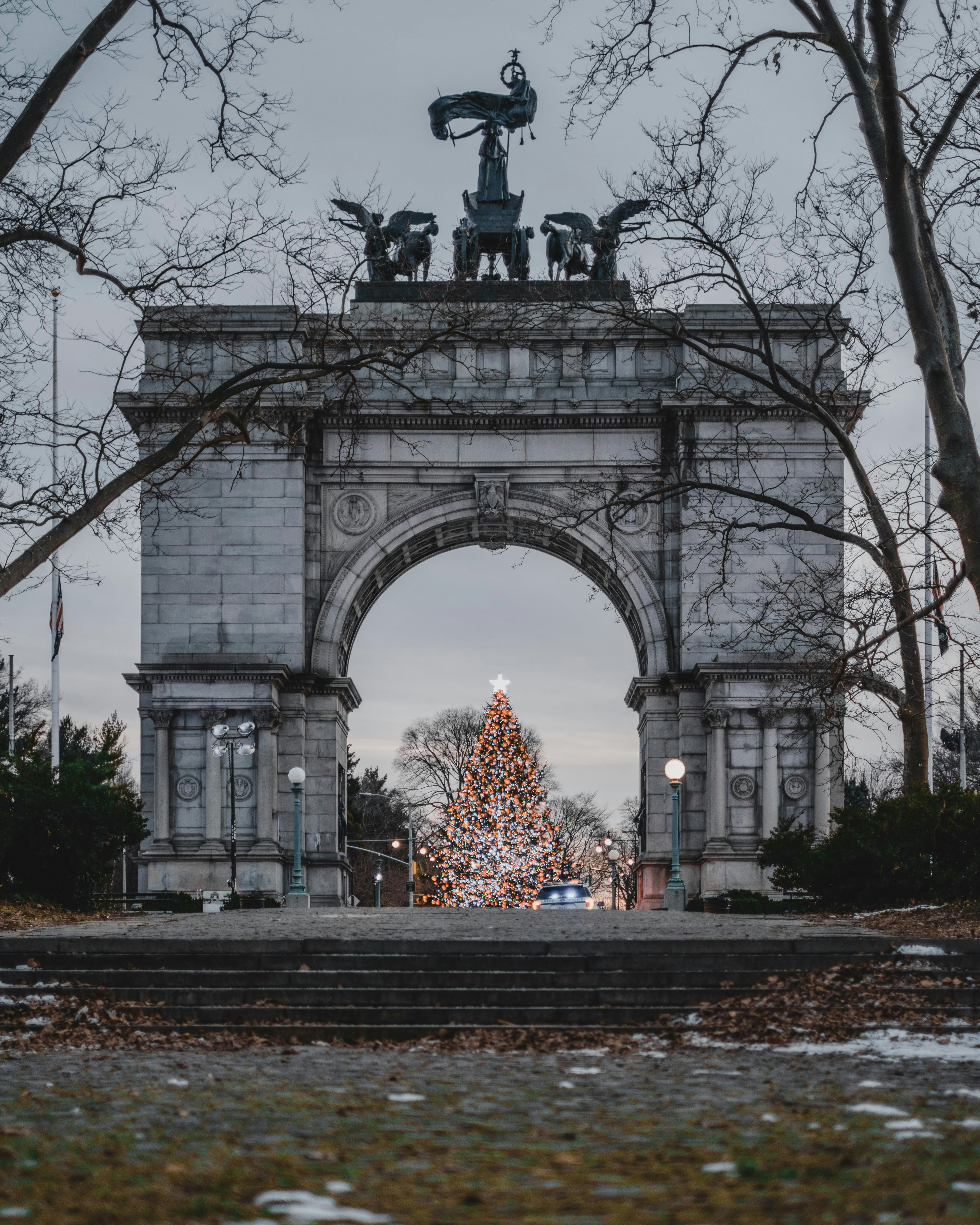 A christmas tree in front of a stone arch photo – Free Brooklyn Image ...