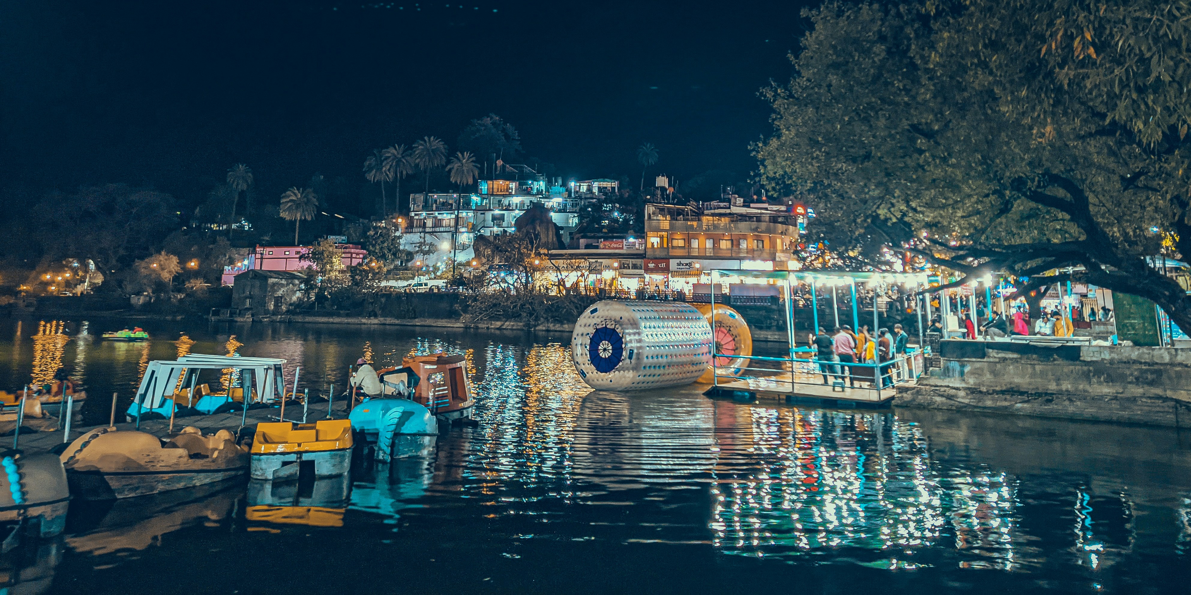 a group of boats floating on top of a lake
