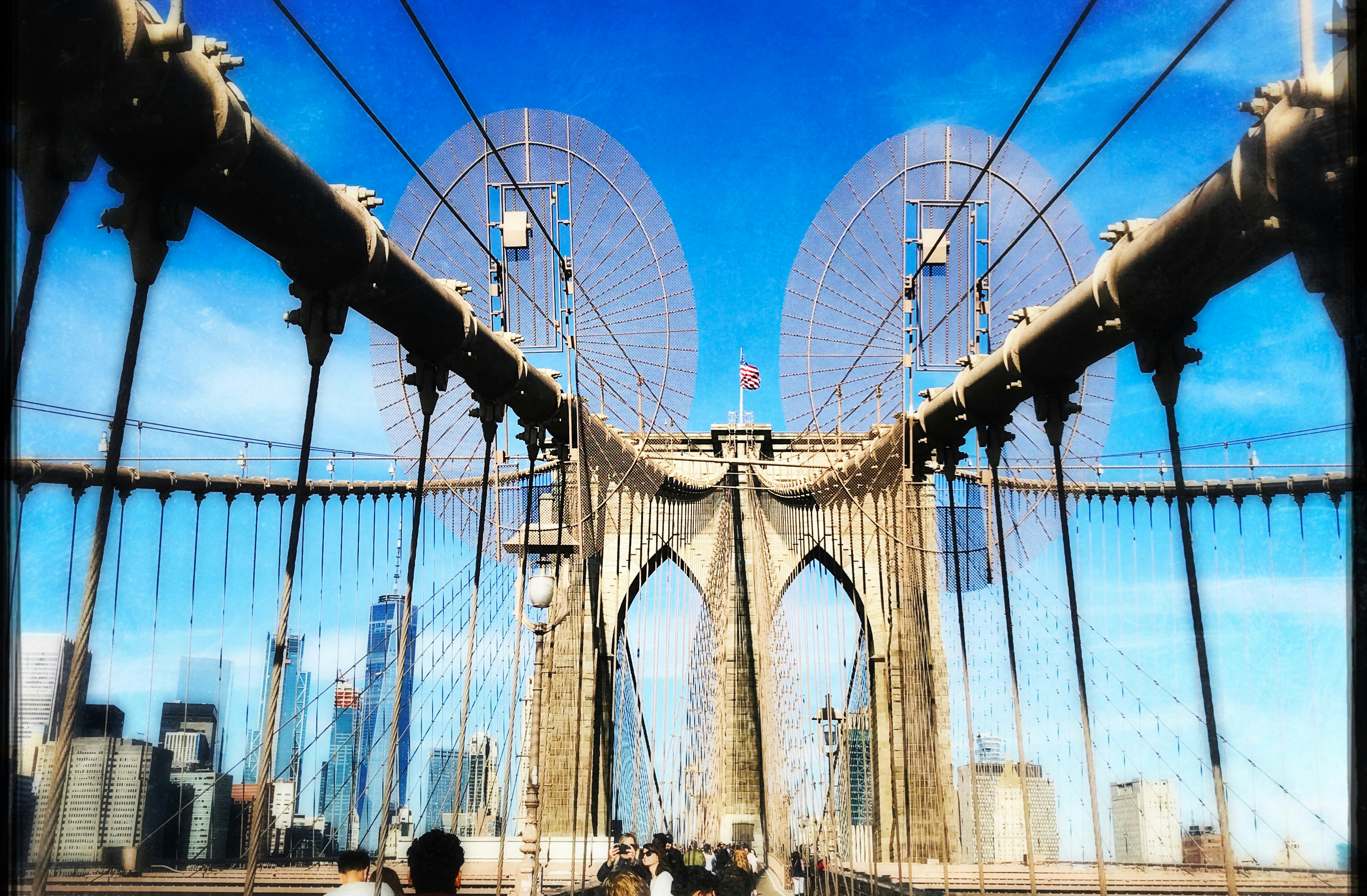 A group of people walking across a bridge photo – Free Bridges Image on ...