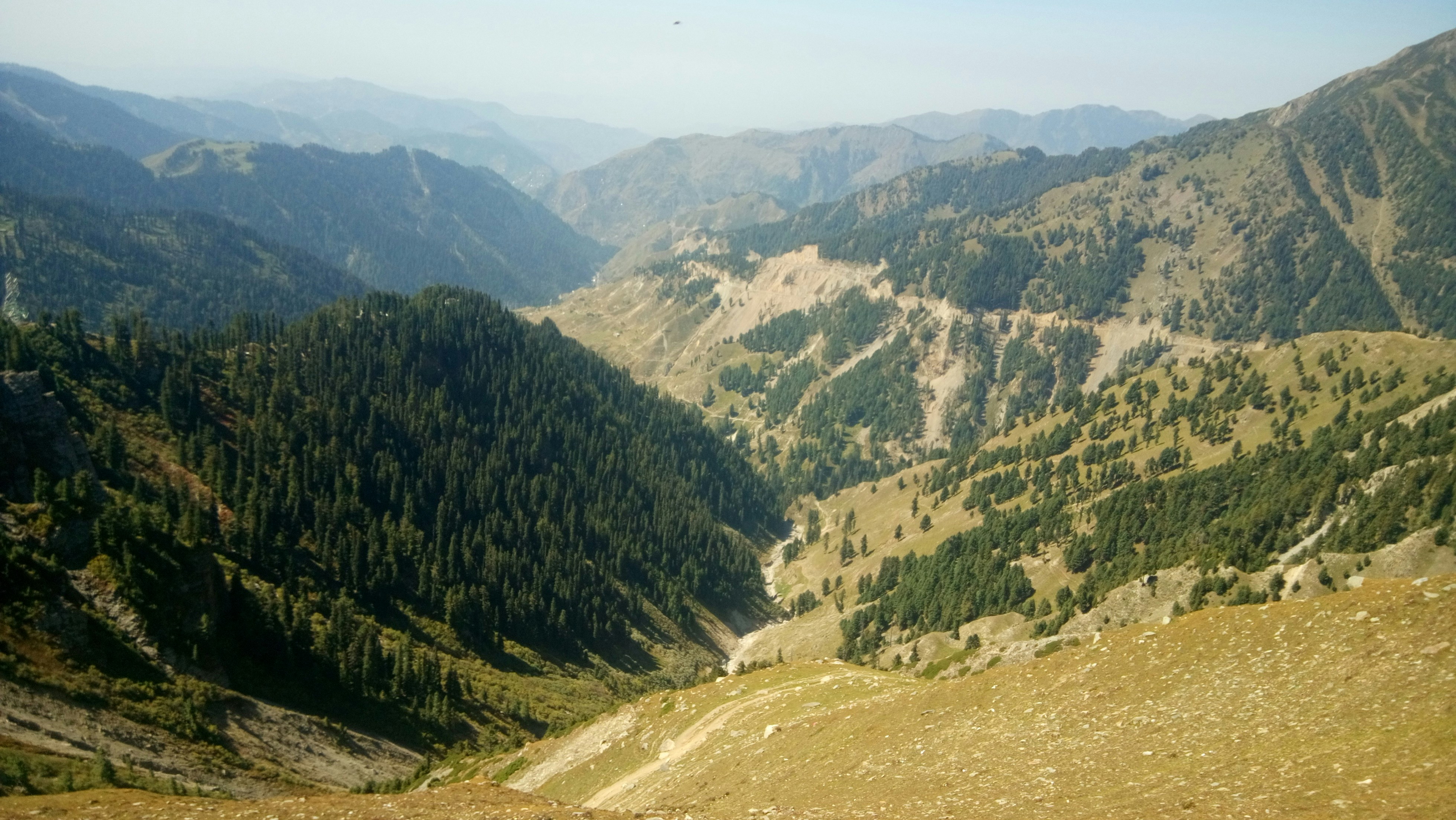 A view of a valley with mountains in the background photo – Free Nature ...