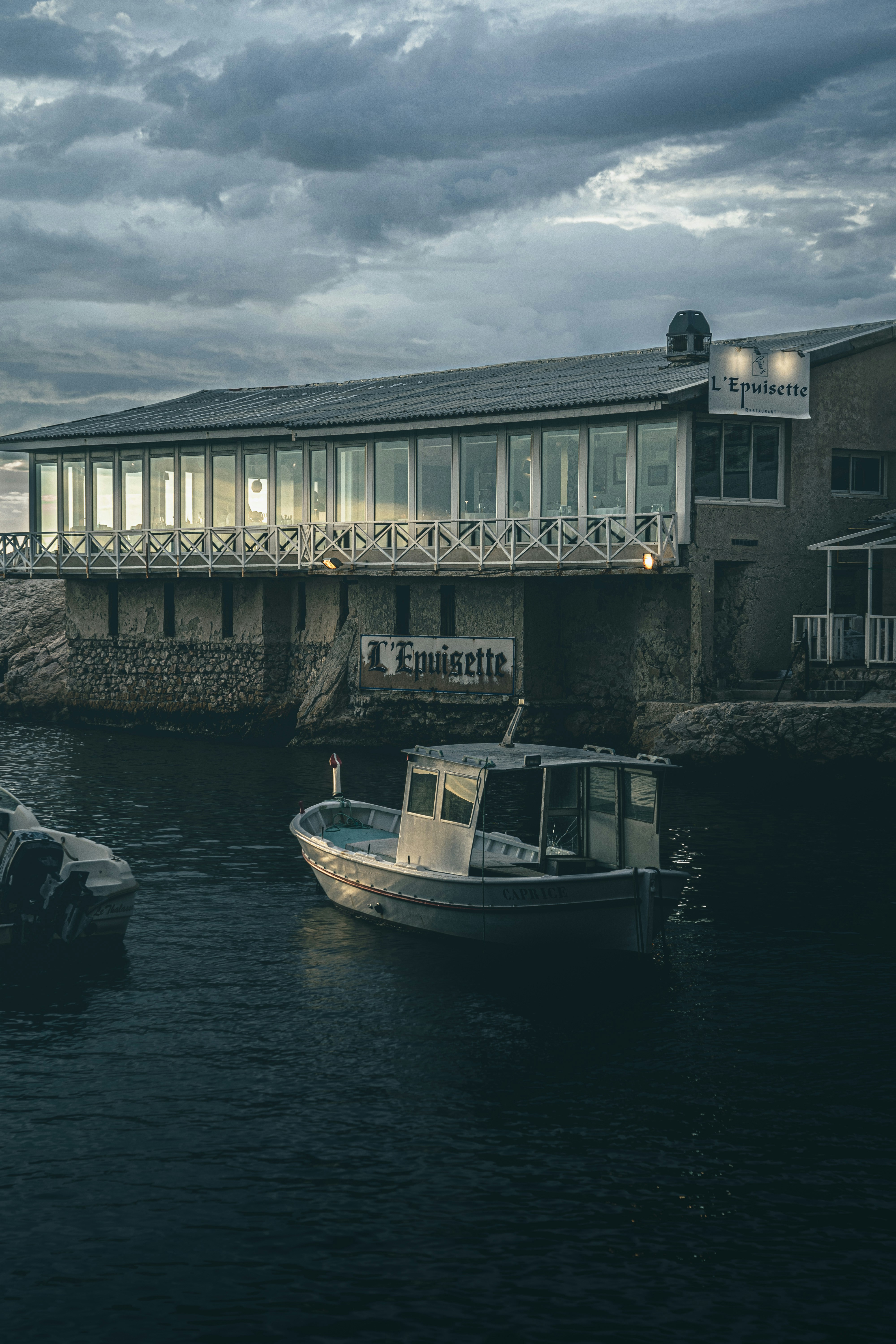 Dusk at the Harbor: Glass-Walled Quay and a Small Boat