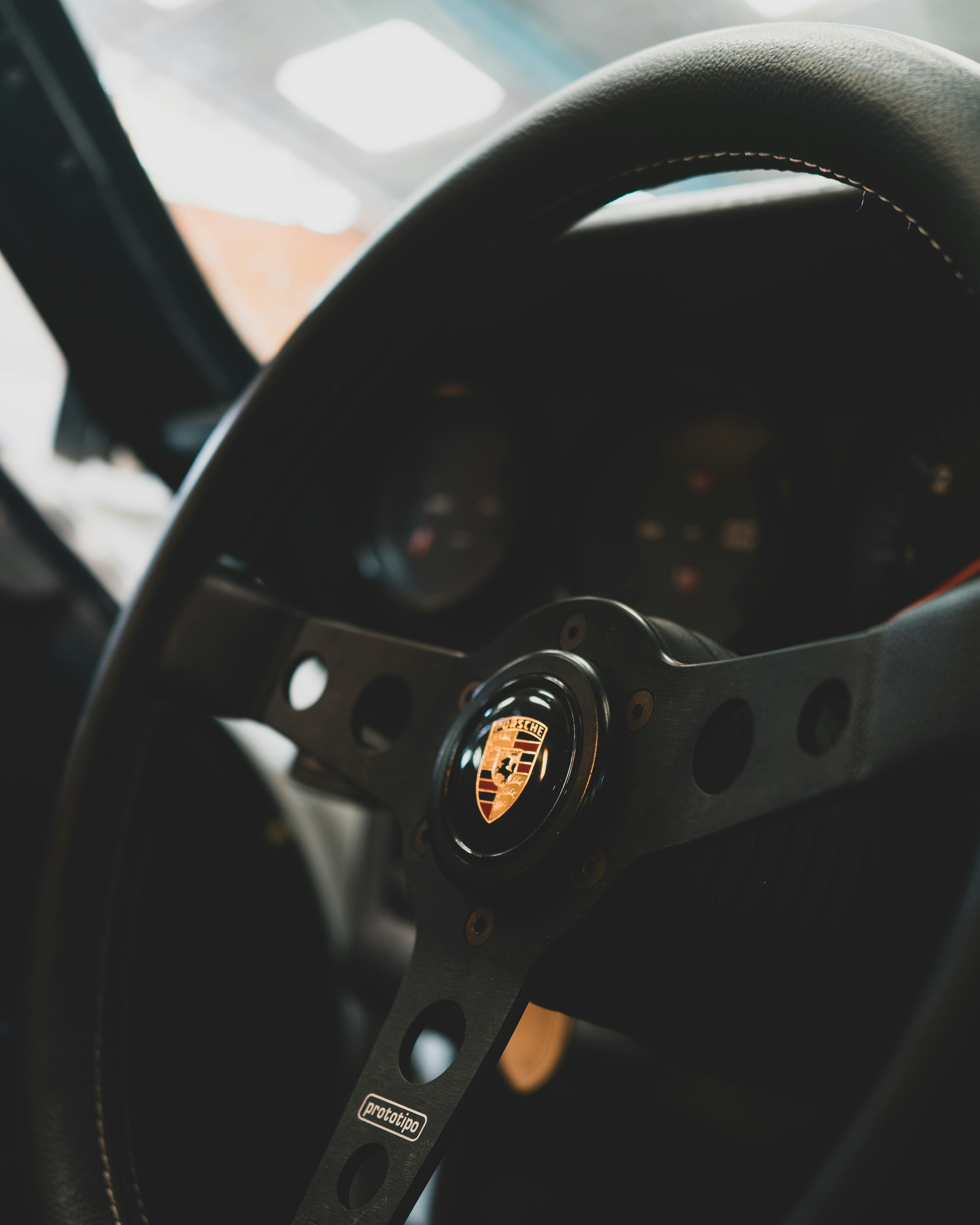 Close-Up of Porsche Steering Wheel: Craft in Steel and Leather at the Heart of the Cockpit