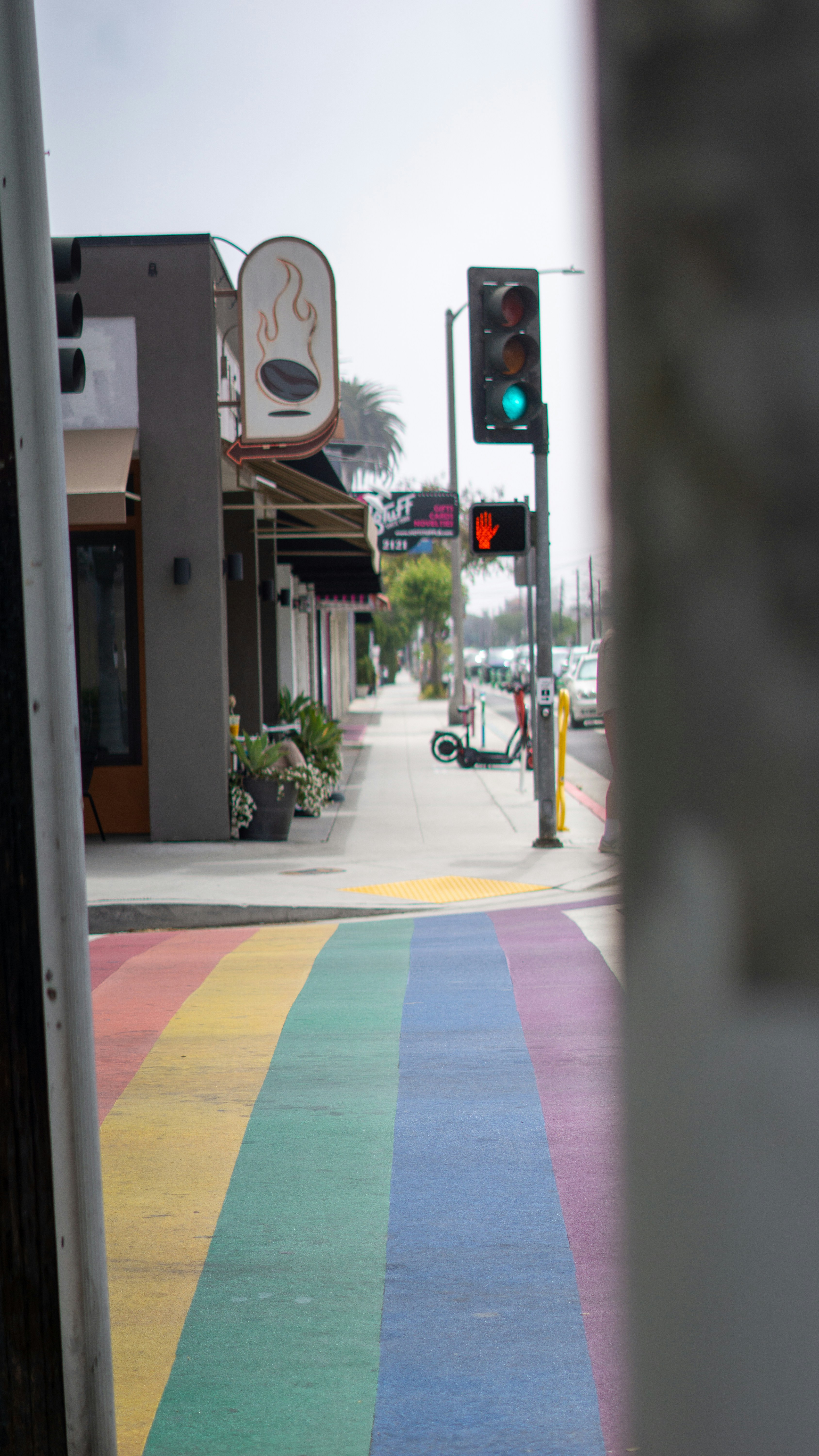 A rainbow painted street with a traffic light photo – Free Usa Image on ...