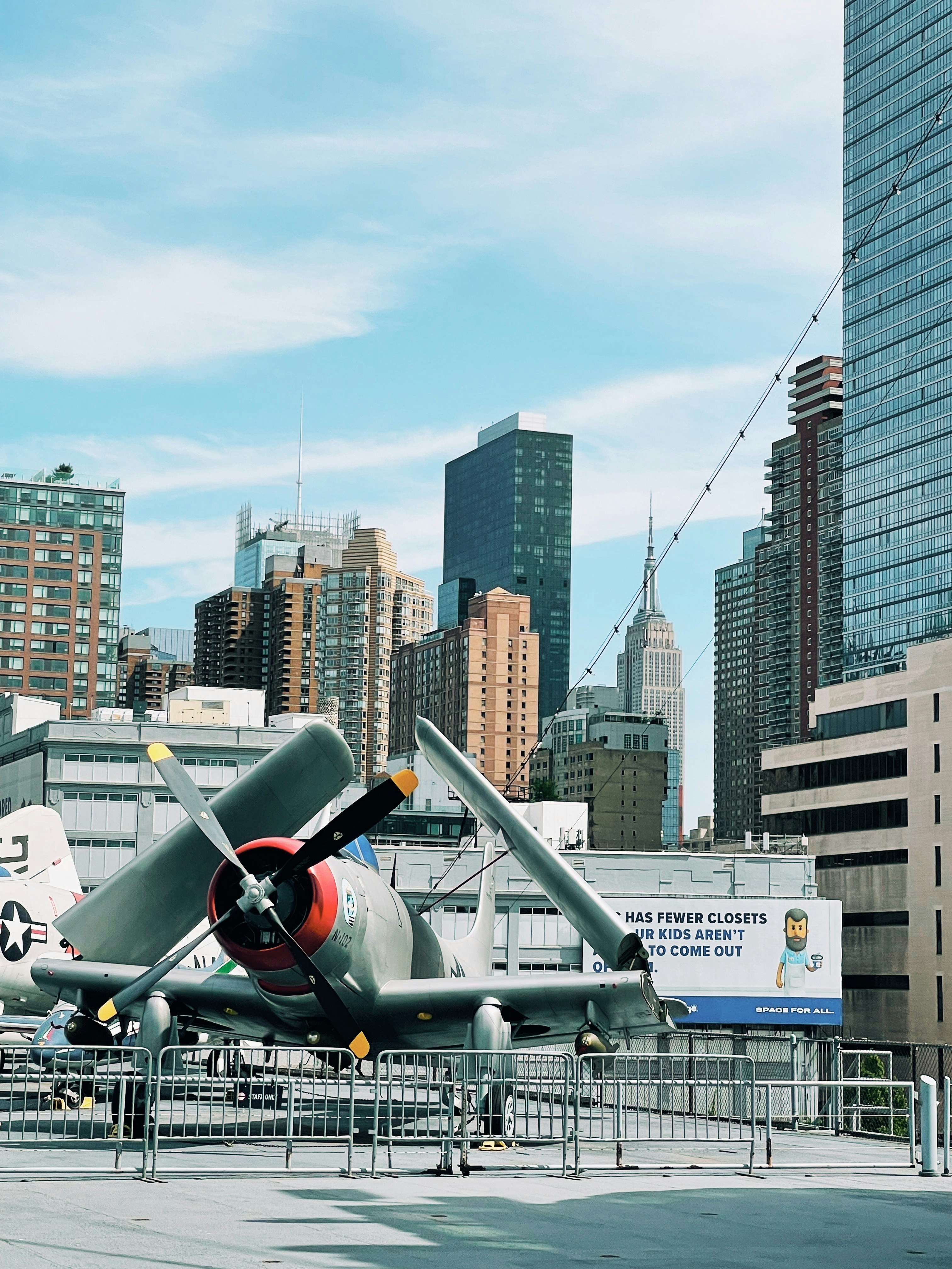 Vintage Warbird Framed by Midtown's Glass Giants