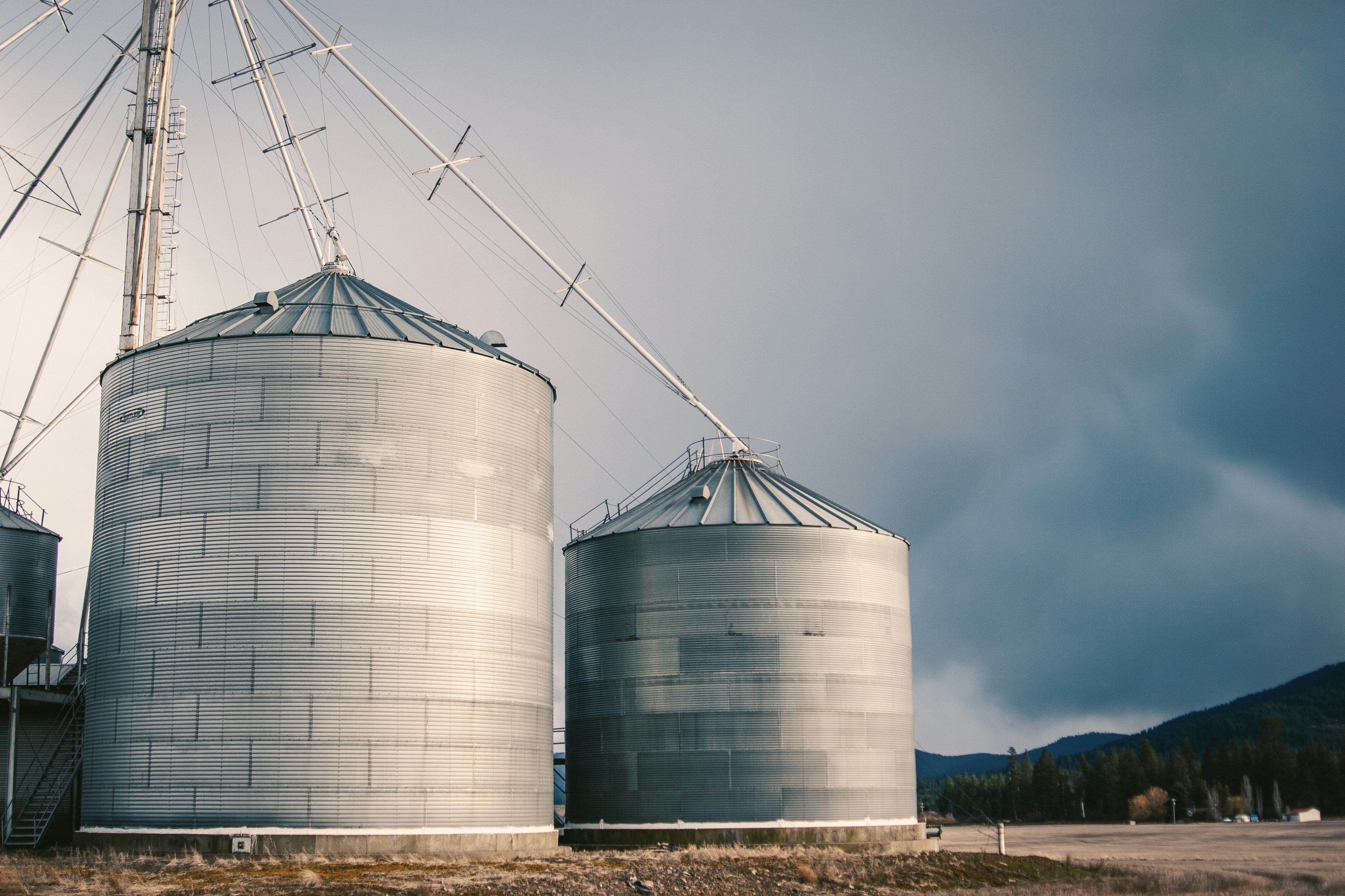 A couple of large metal silos sitting next to each other photo – Free ...