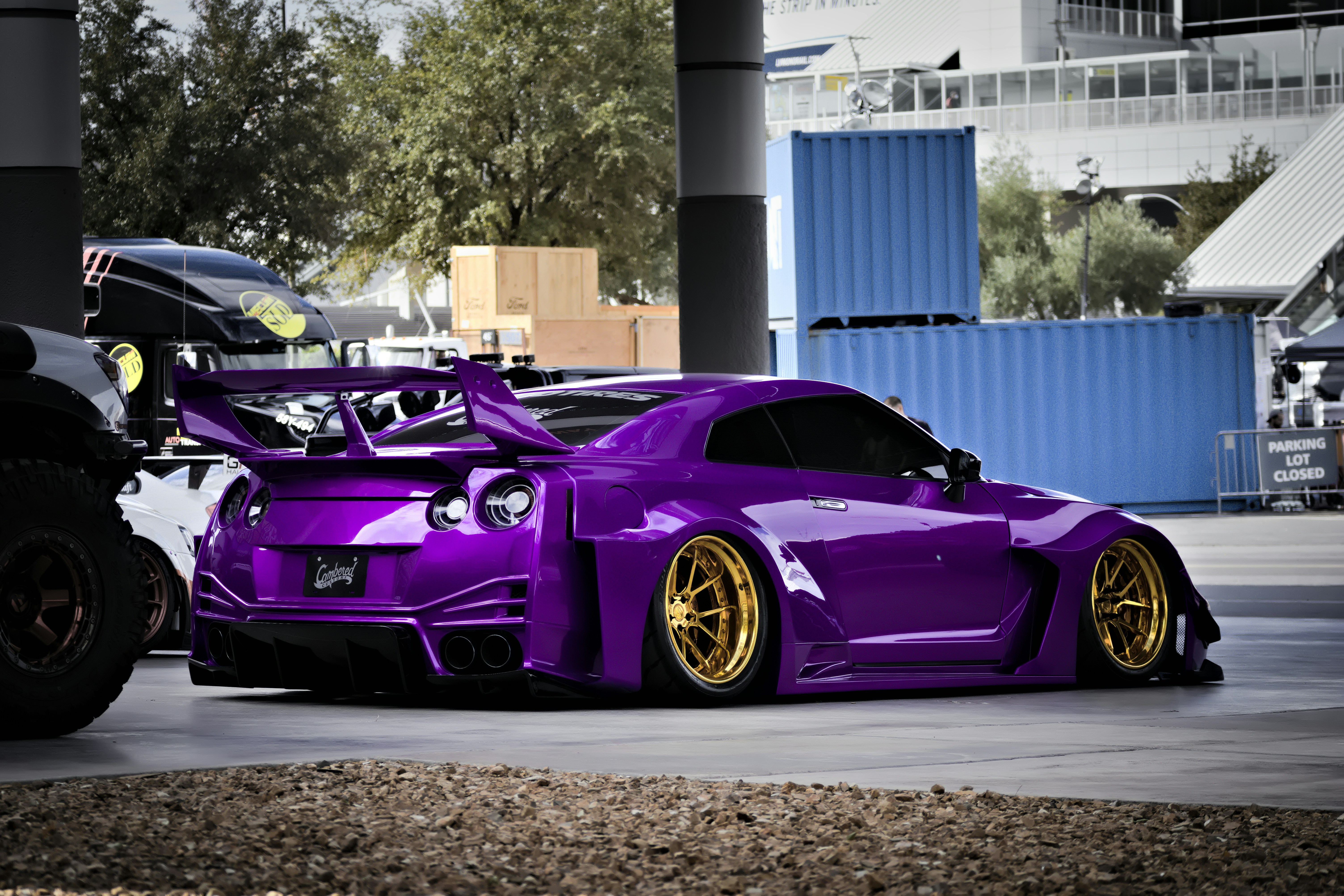 A purple sports car parked in a parking lot photo – Free Car Image on ...