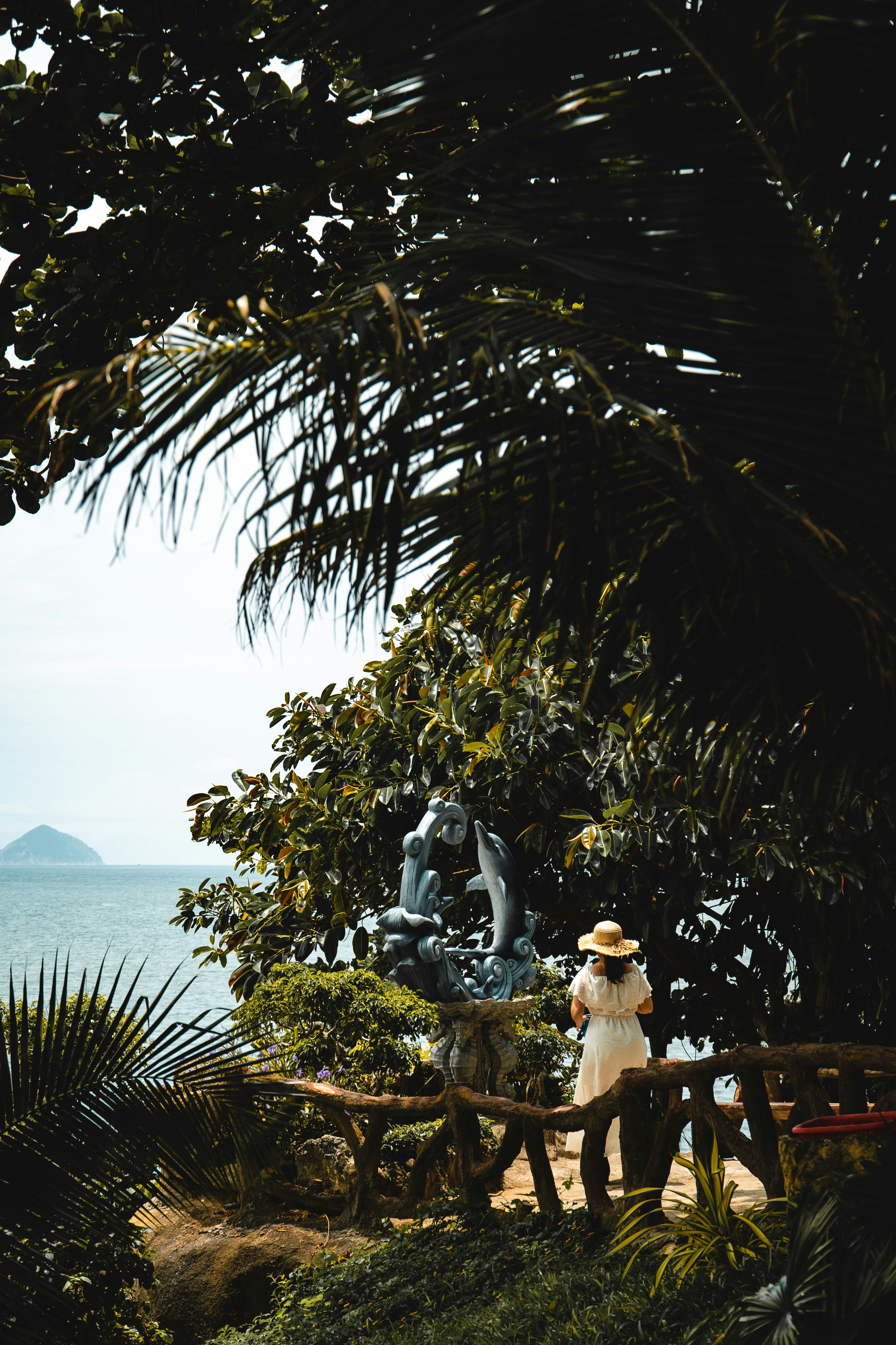 Seaside Terrace Vista with a Bejeweled Sculpture and a Sunhat Figure
