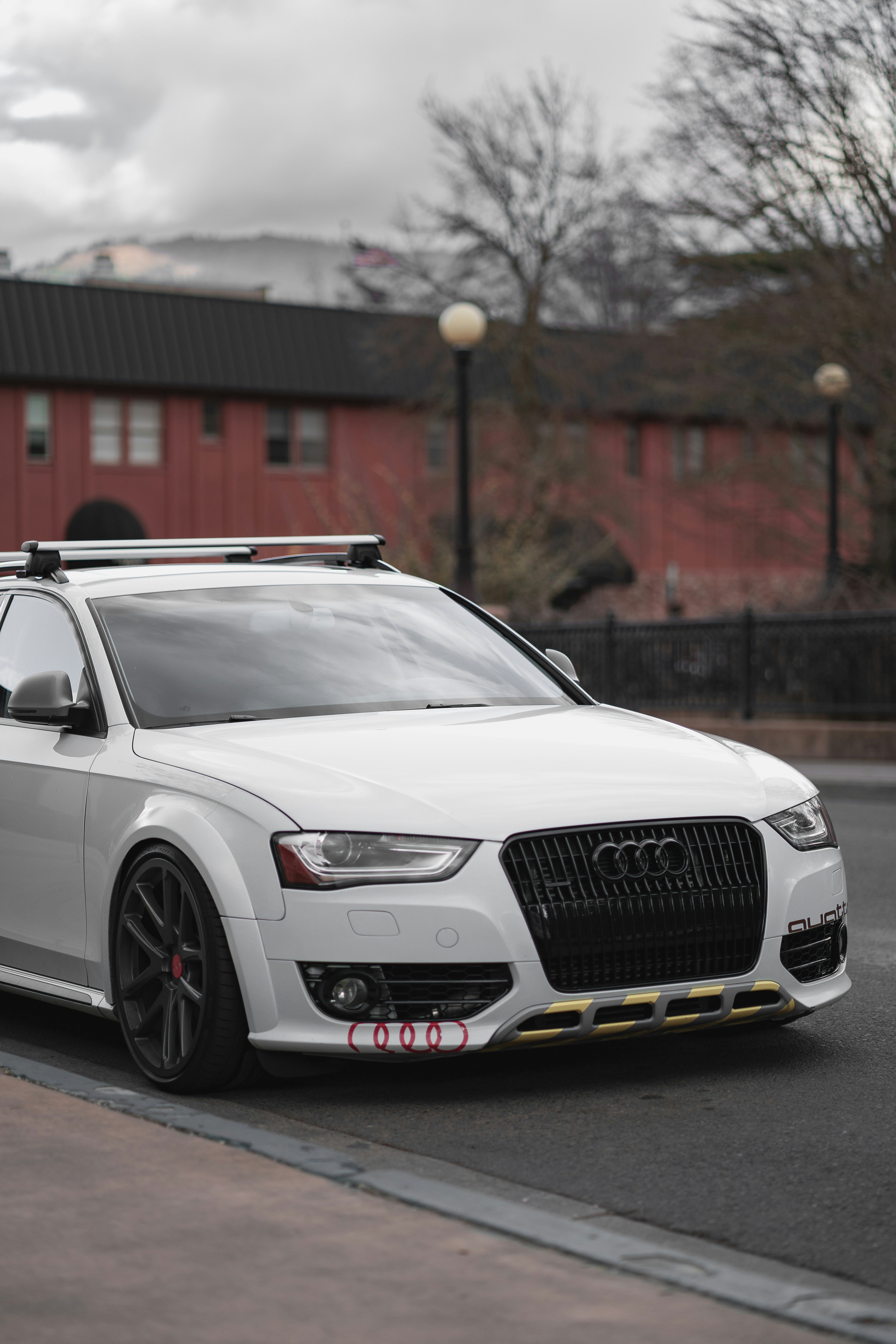 Urban Elegance: The White Audi in a Quiet Street Scene