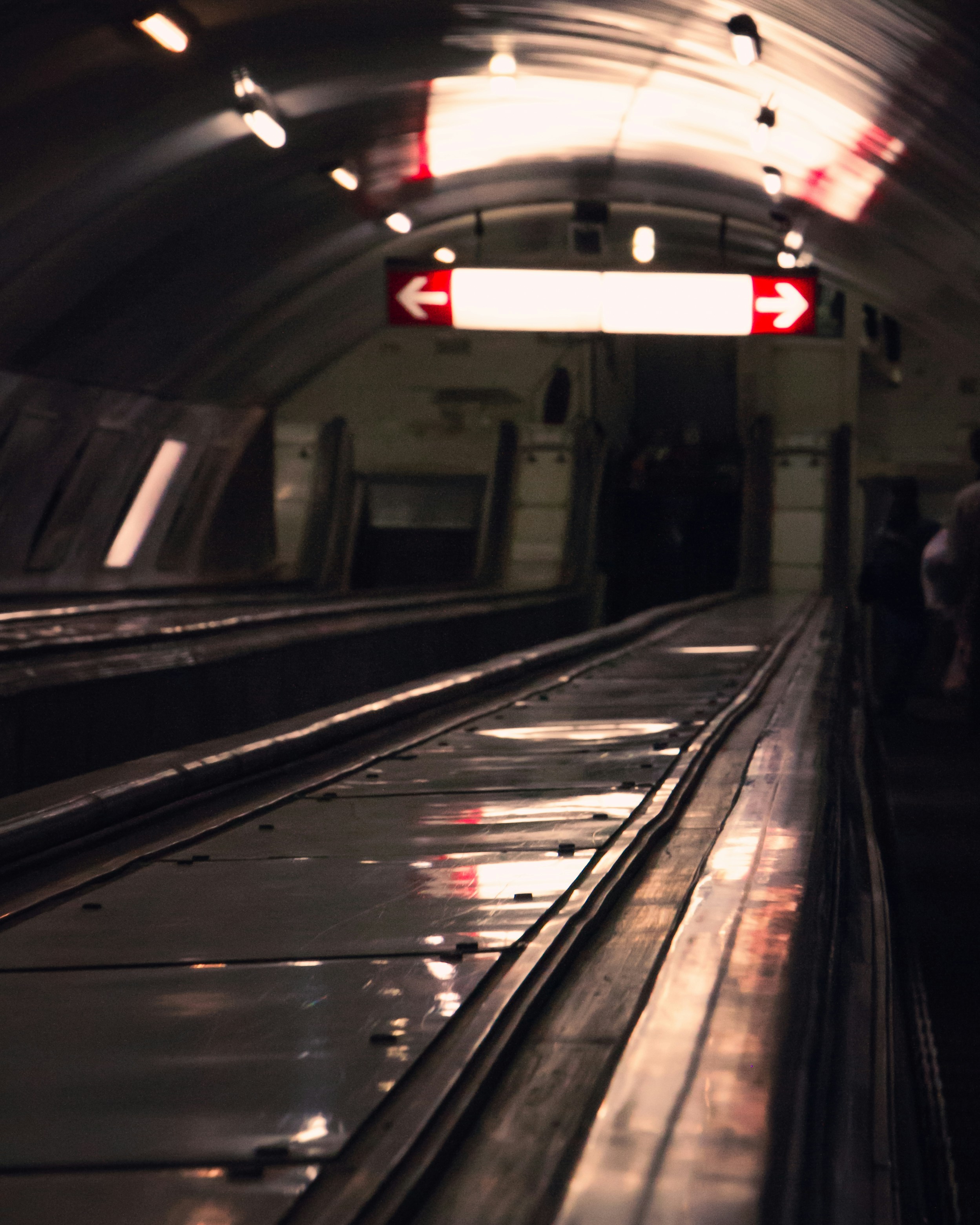 Under the Arc: Reflections and Red Arrows in a Subterranean Platform