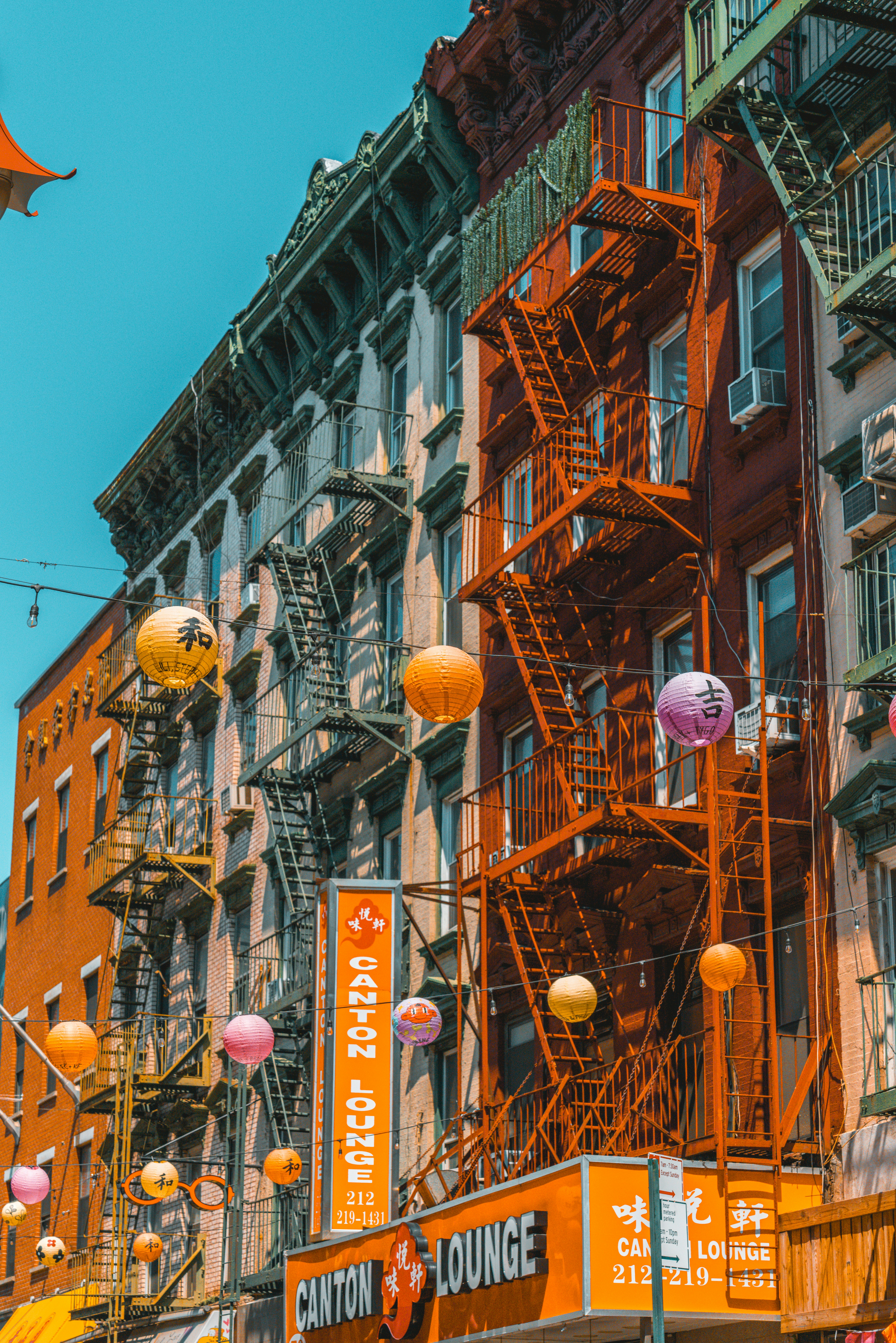 Orange Iron Staircase Framing a Lantern-Lit Chinatown Block