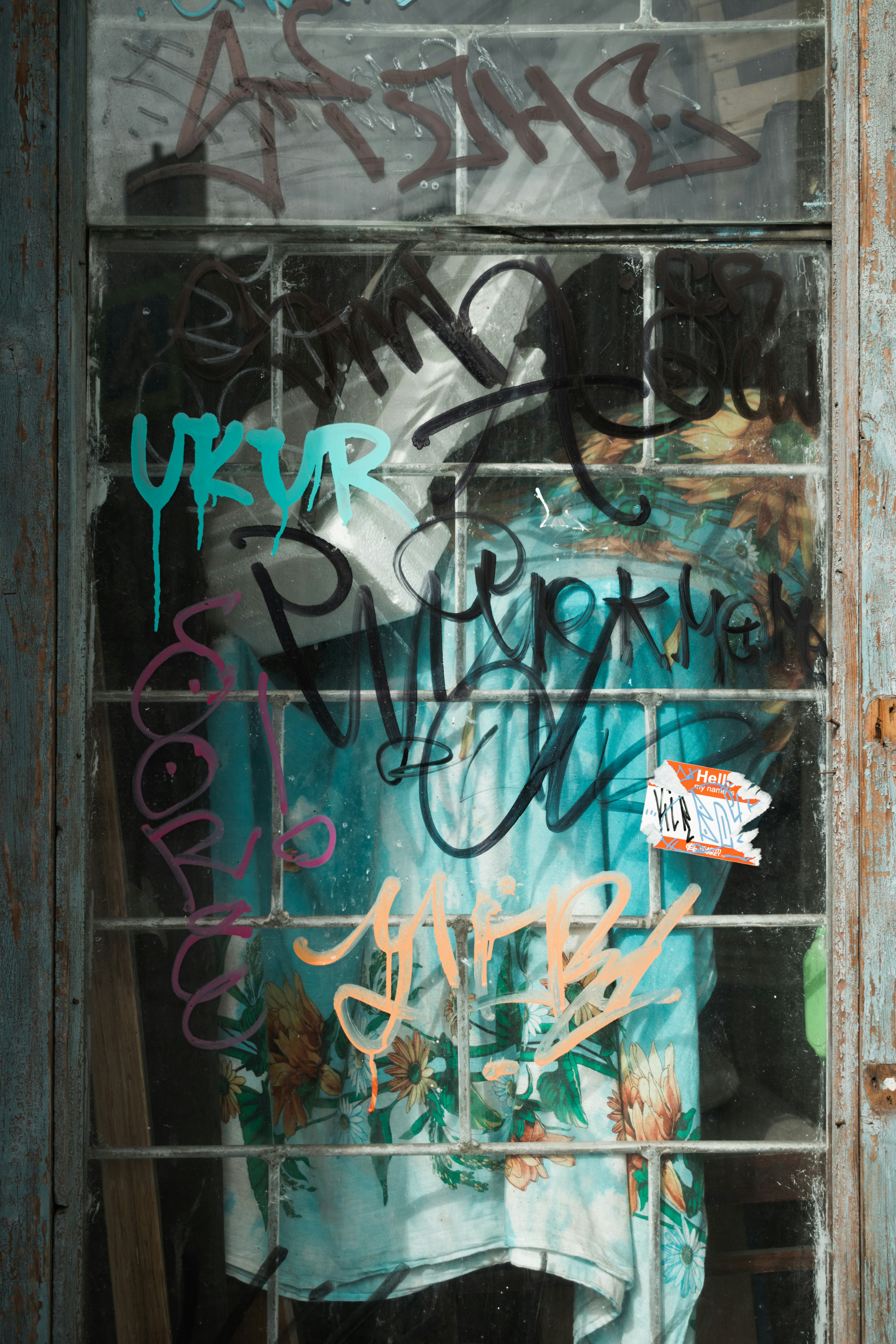 A window that has some graffiti on it photo – Free Graffiti Image on ...