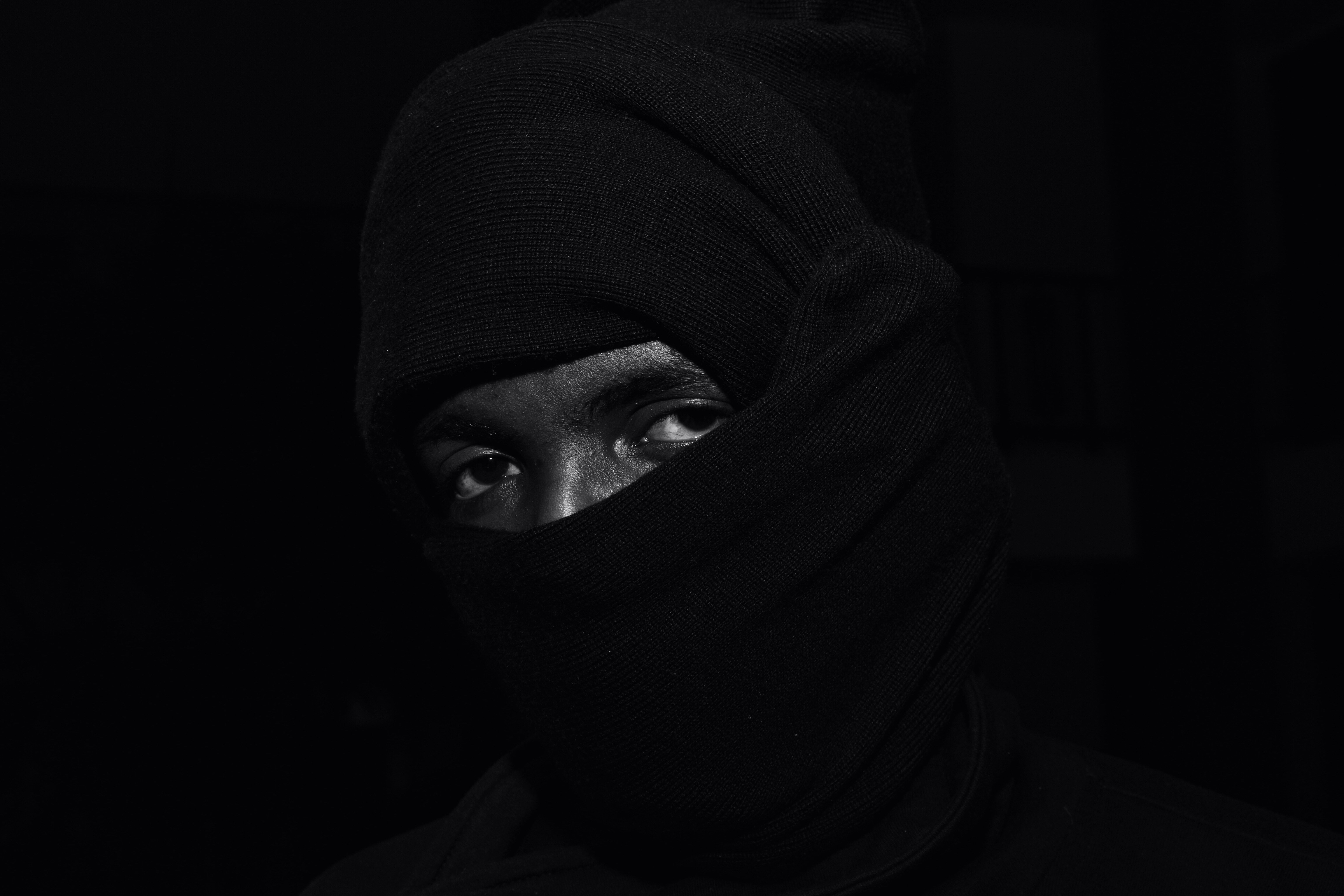 A person wearing a black mask in the dark photo – Free Uk Image on Unsplash