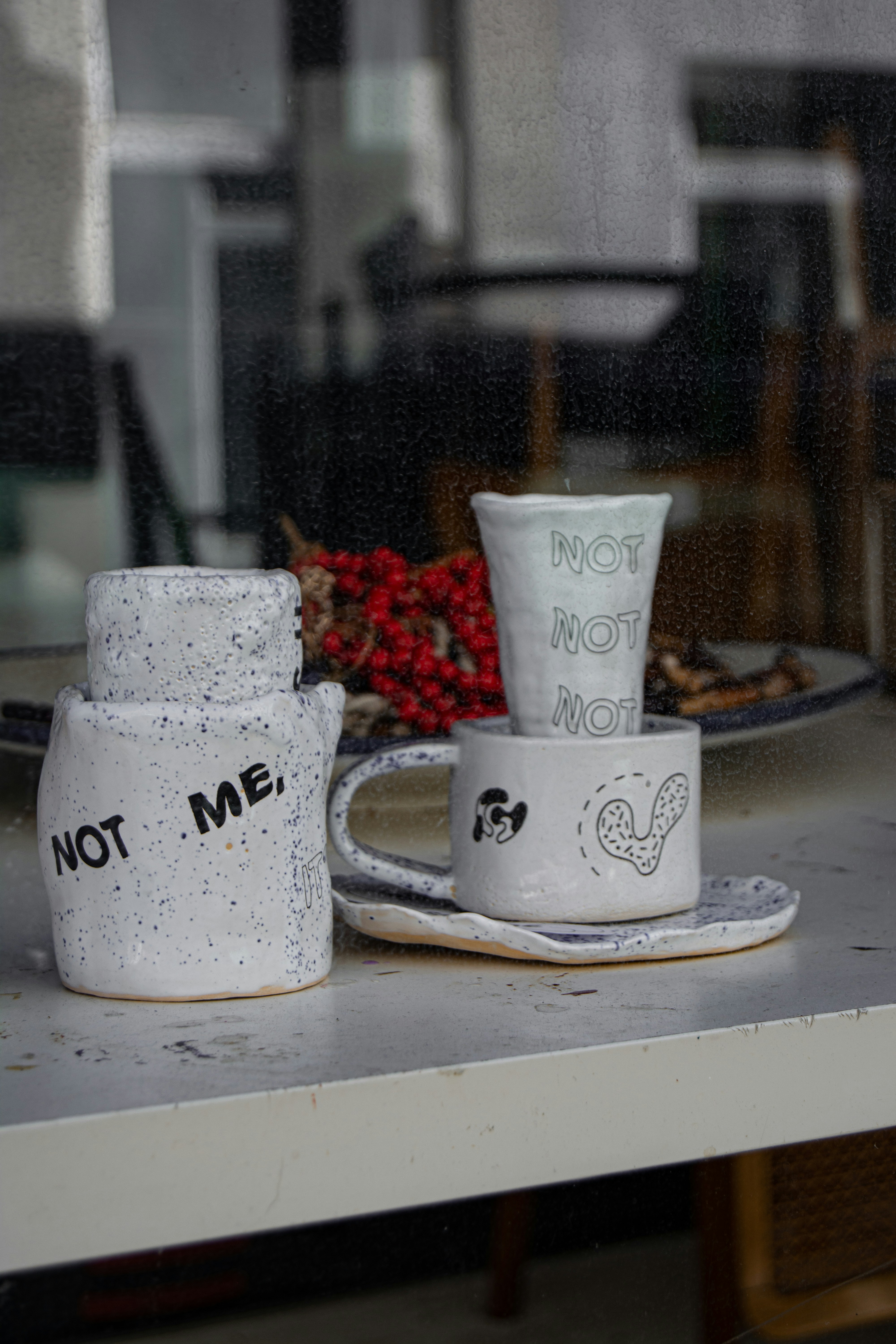 Noteworthy Ceramics: A Duo of Speckled Mugs on a Quiet Studio Table