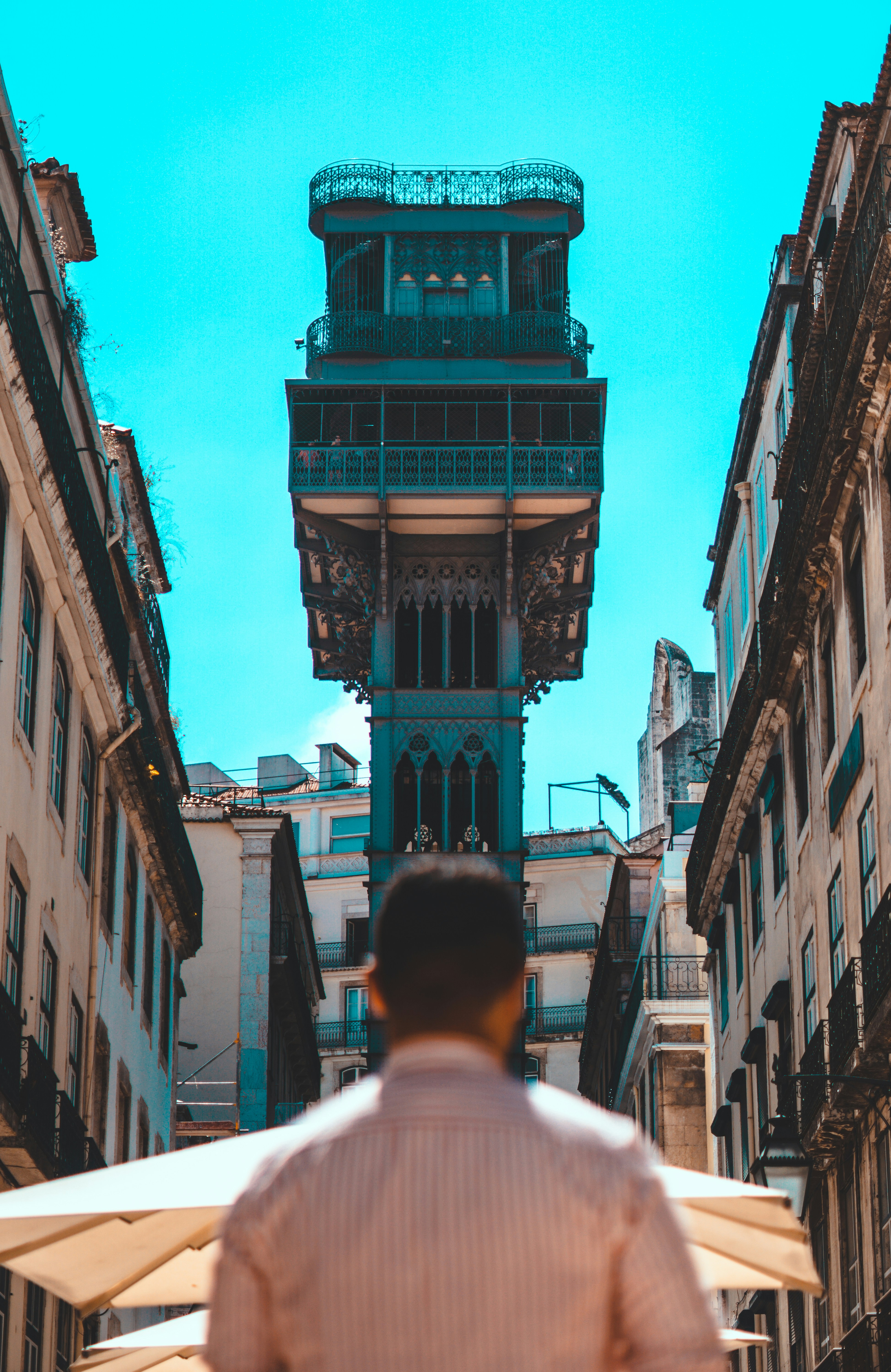 A man standing in front of a tall building photo – Free Lisbon Image on ...
