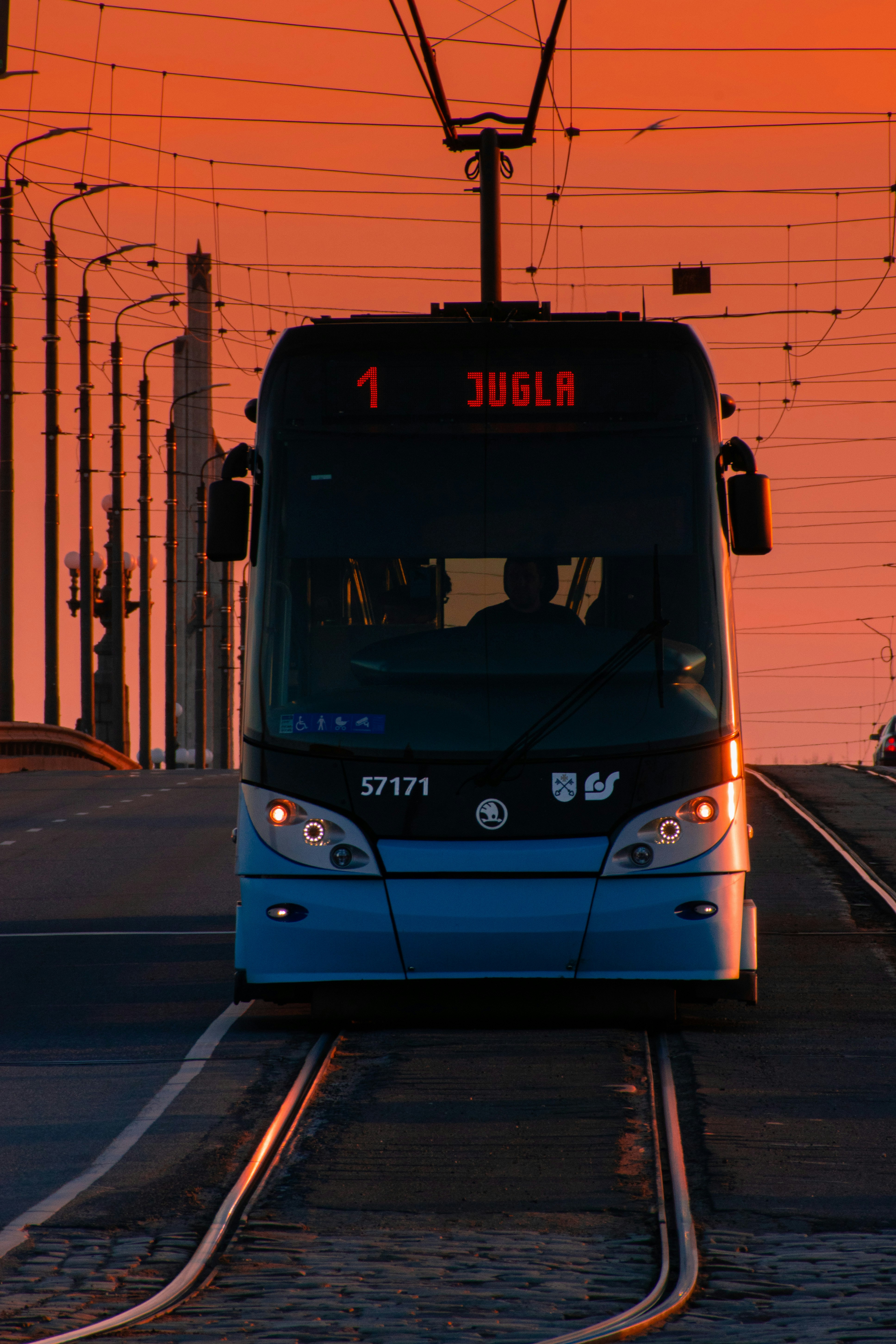 a blue and white bus driving down a street