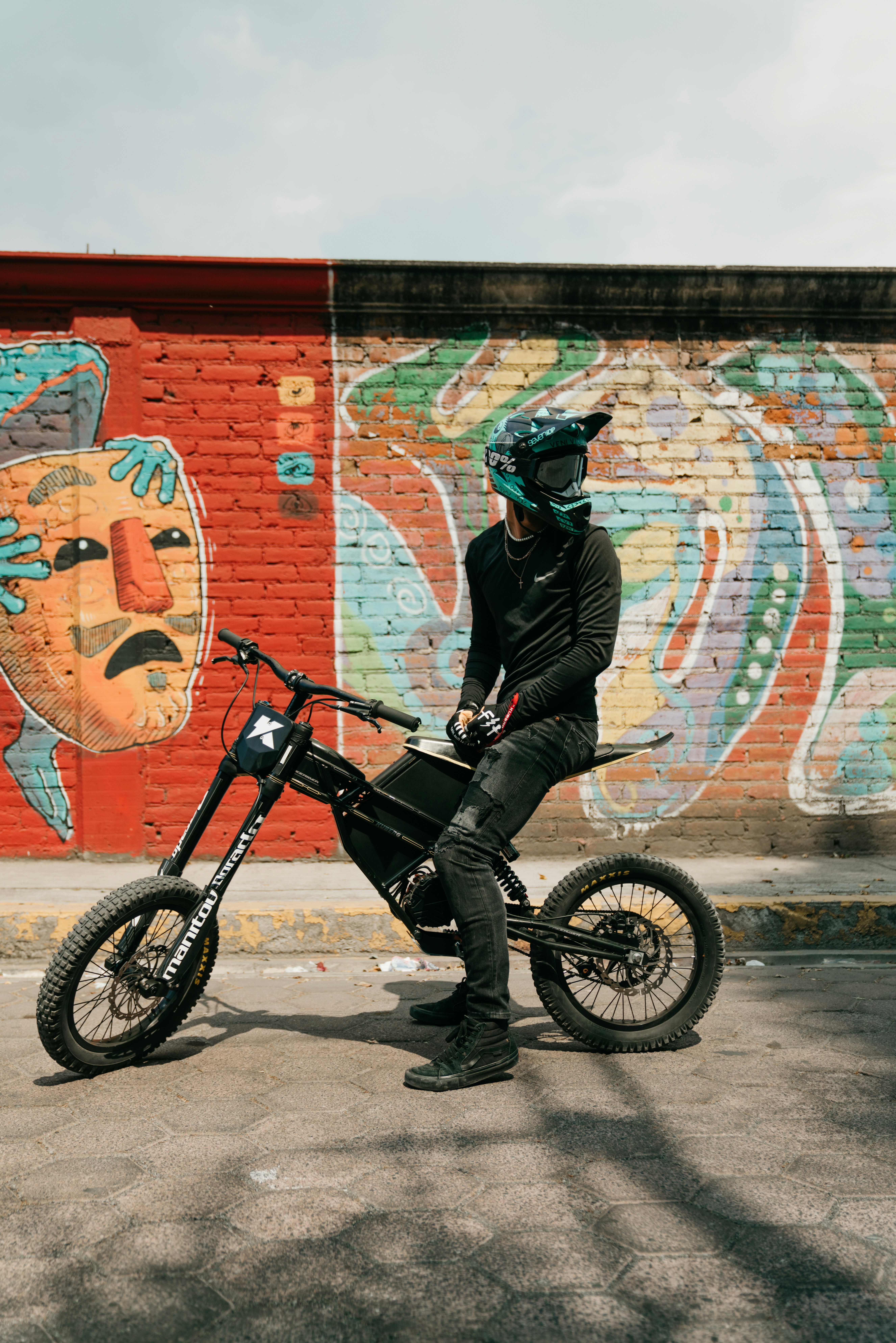 Contour of Quiet Power: Black-Clad Rider Meets Graffiti Wall