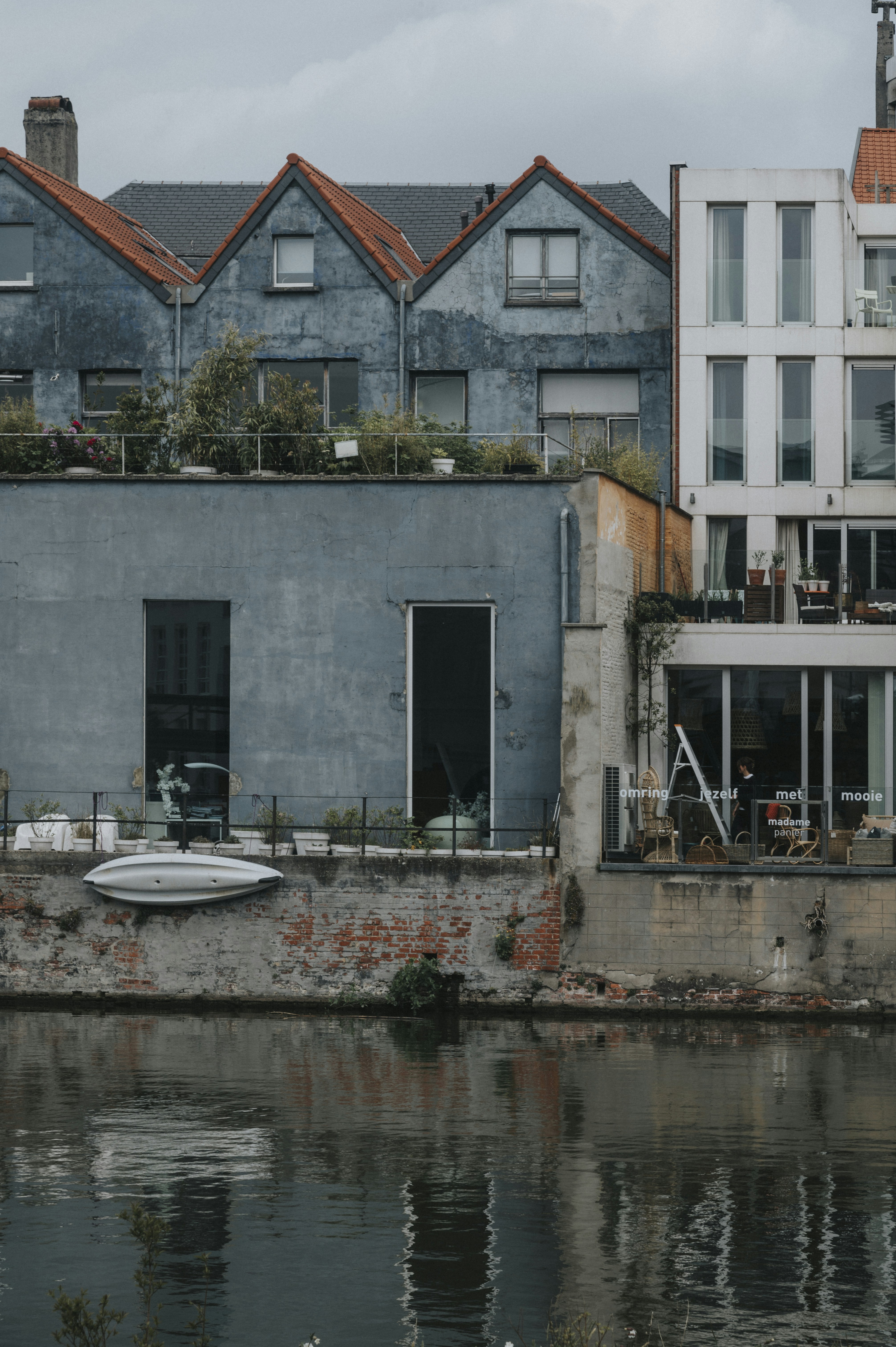 Blue Wall and Riverside Reflections: a Quiet Urban Portrait