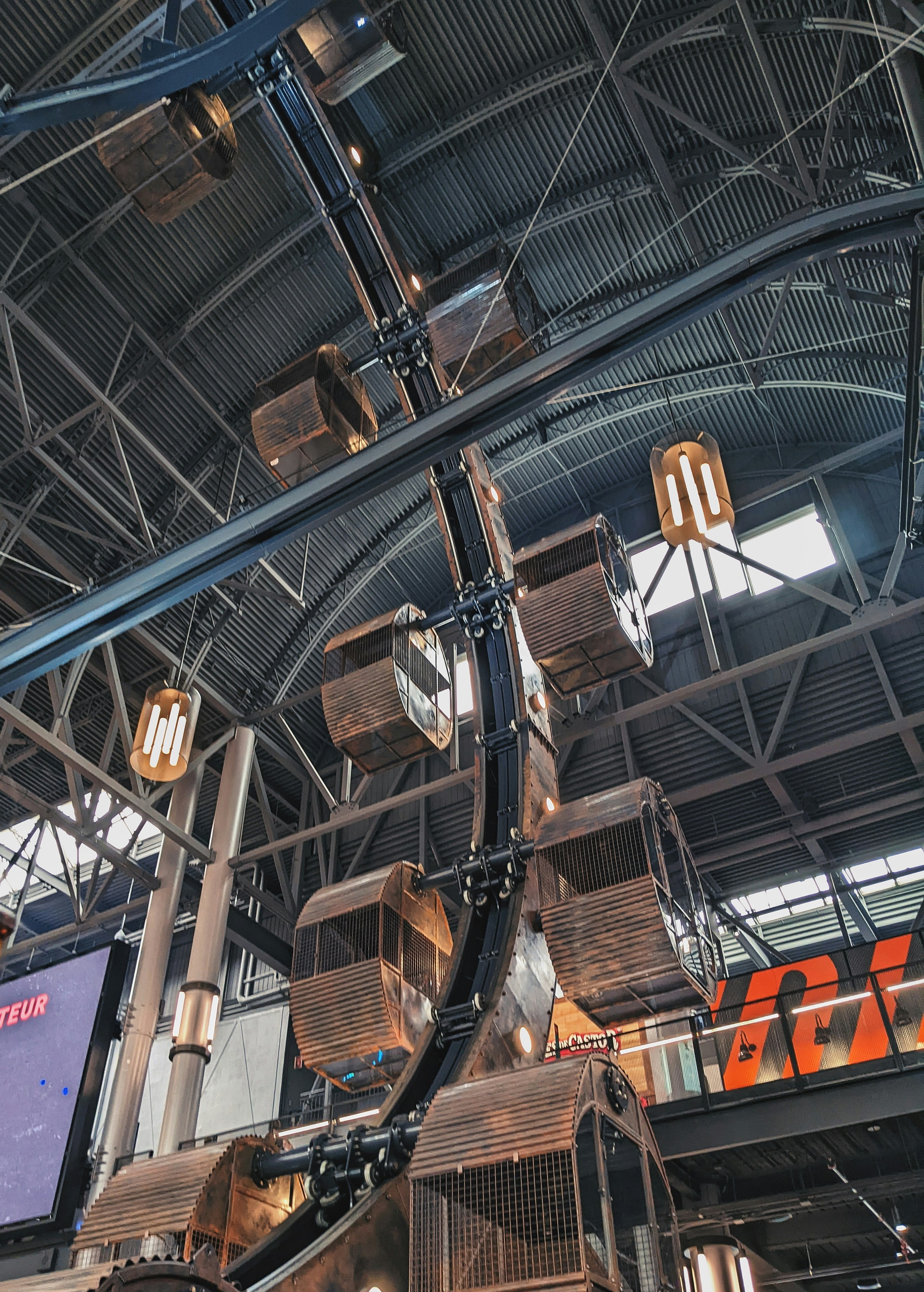 the inside of a building that has a bunch of wooden boxes hanging from the ceiling