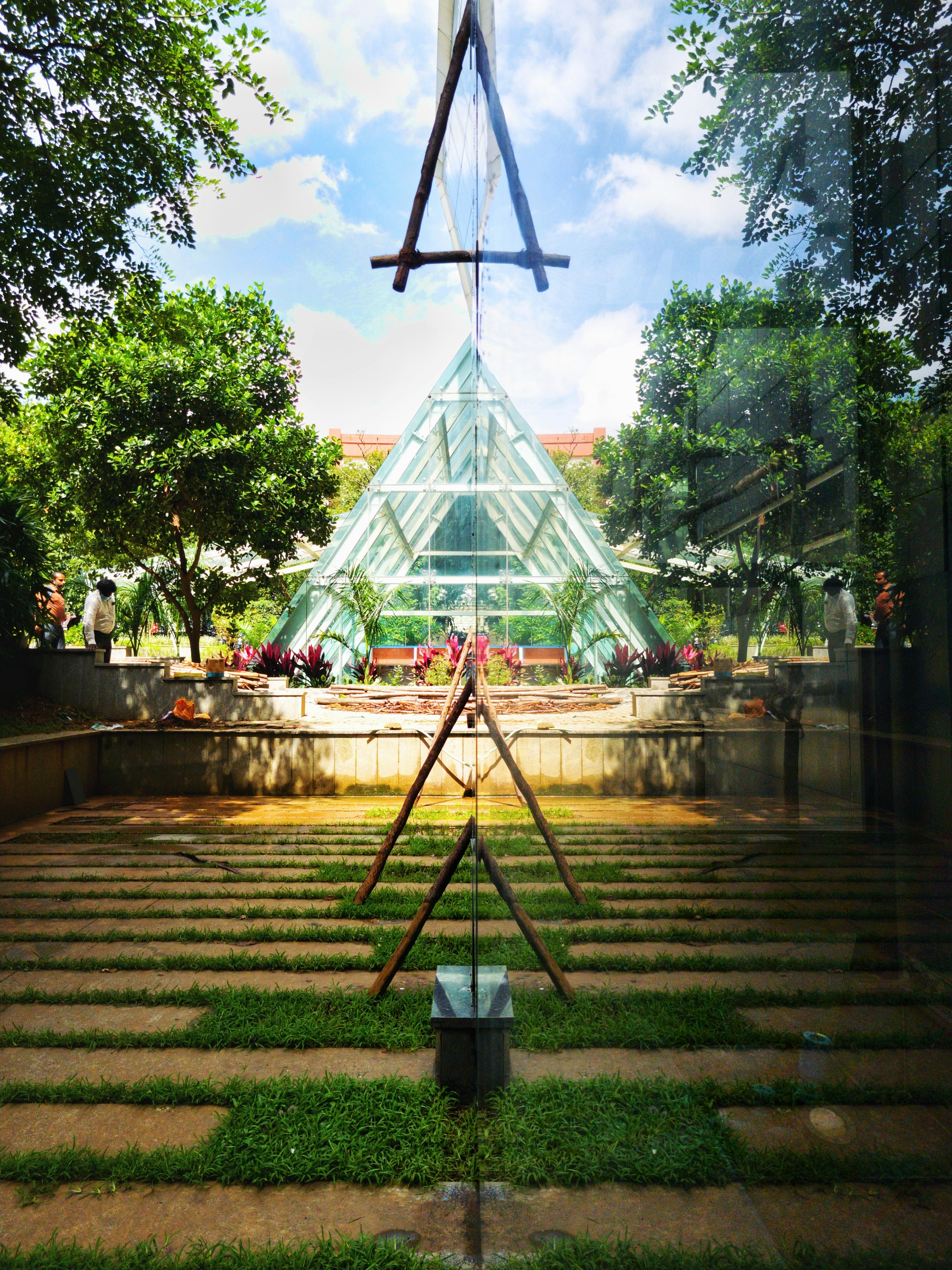 Sunlit Glass Pyramid Framed by Timber Geometry