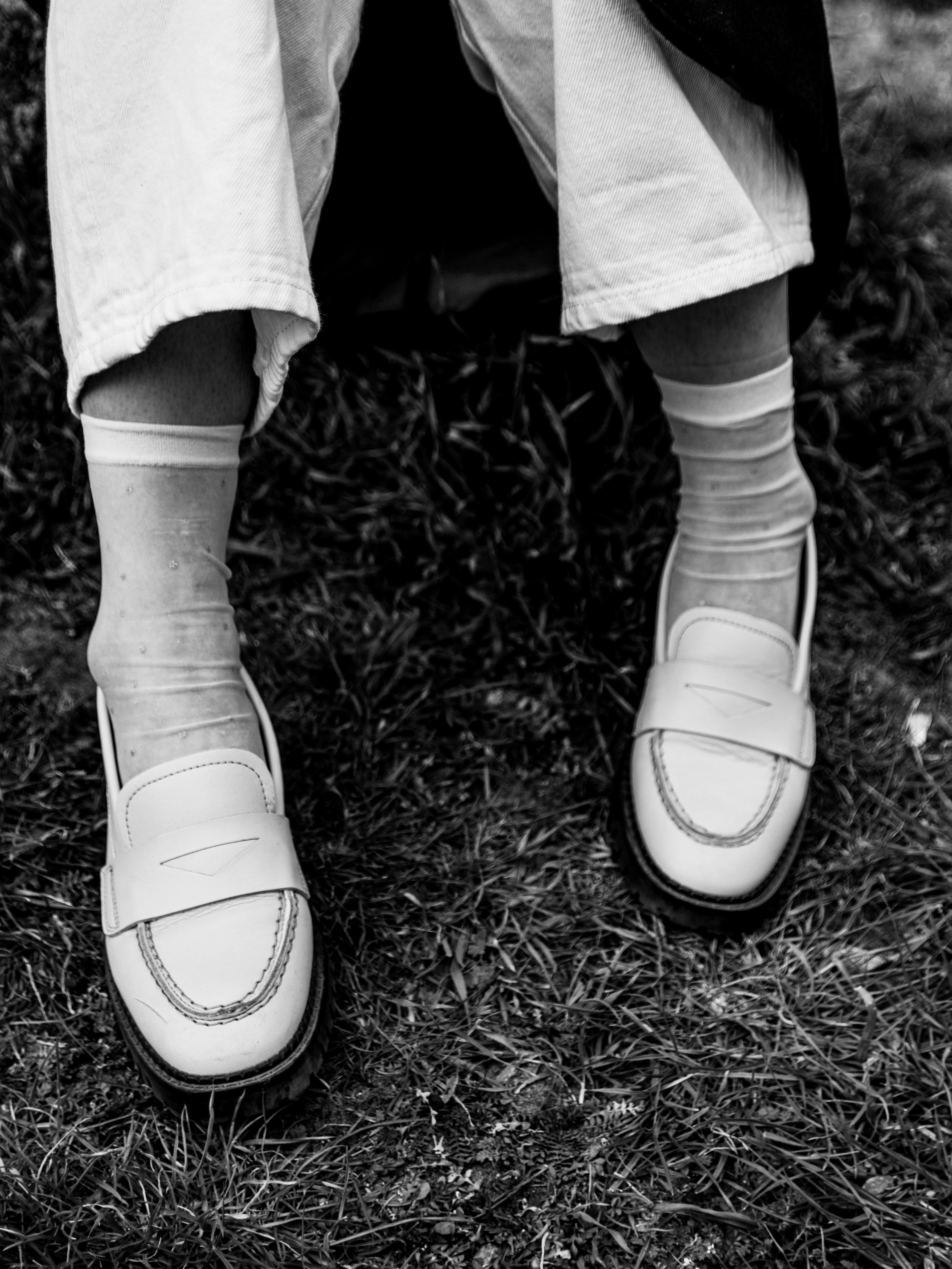 Grassbound Steps: White Loafers on a Quiet Lawn