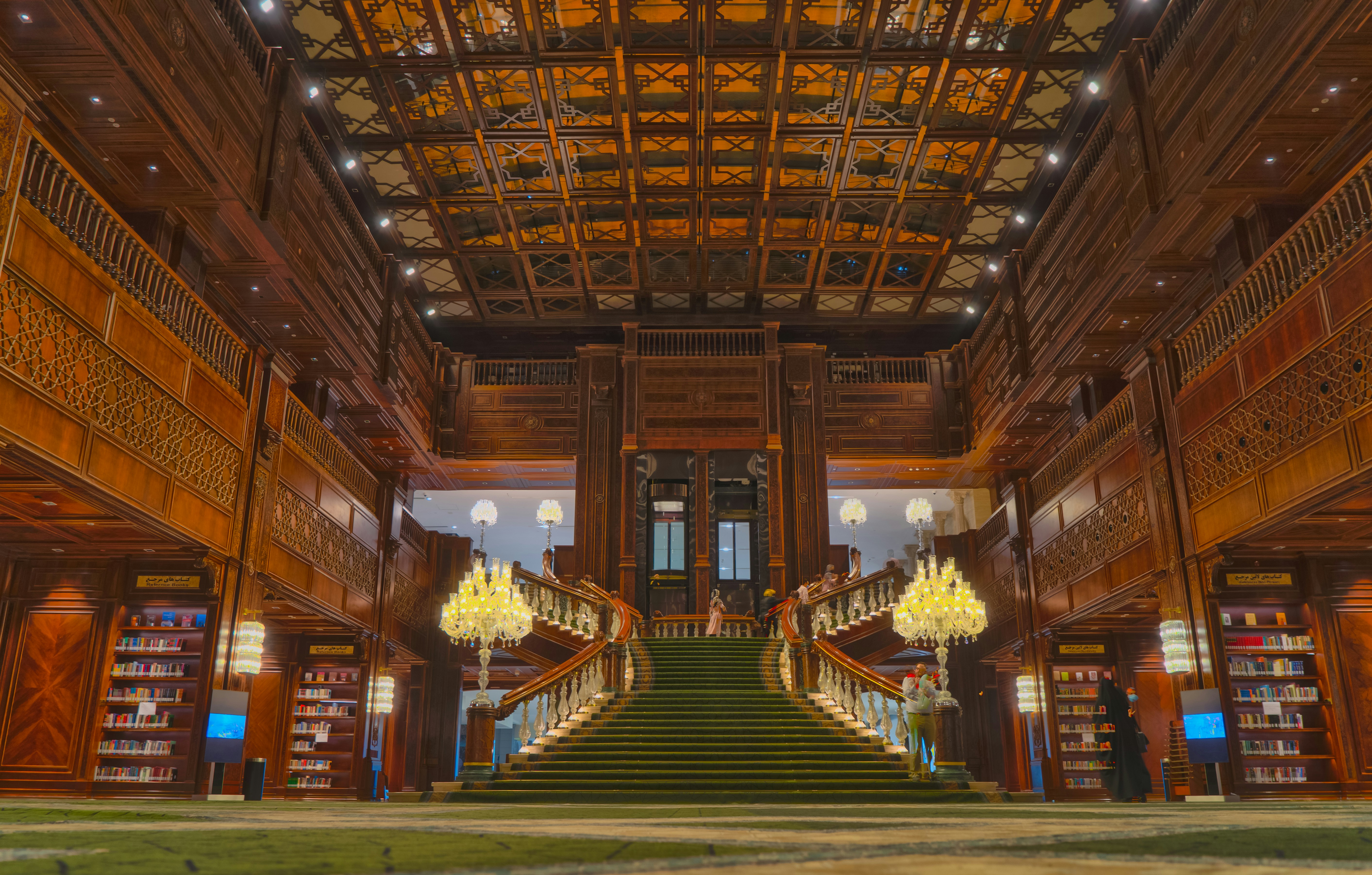 A large library with a staircase and chandelier photo – Free Iran Image ...