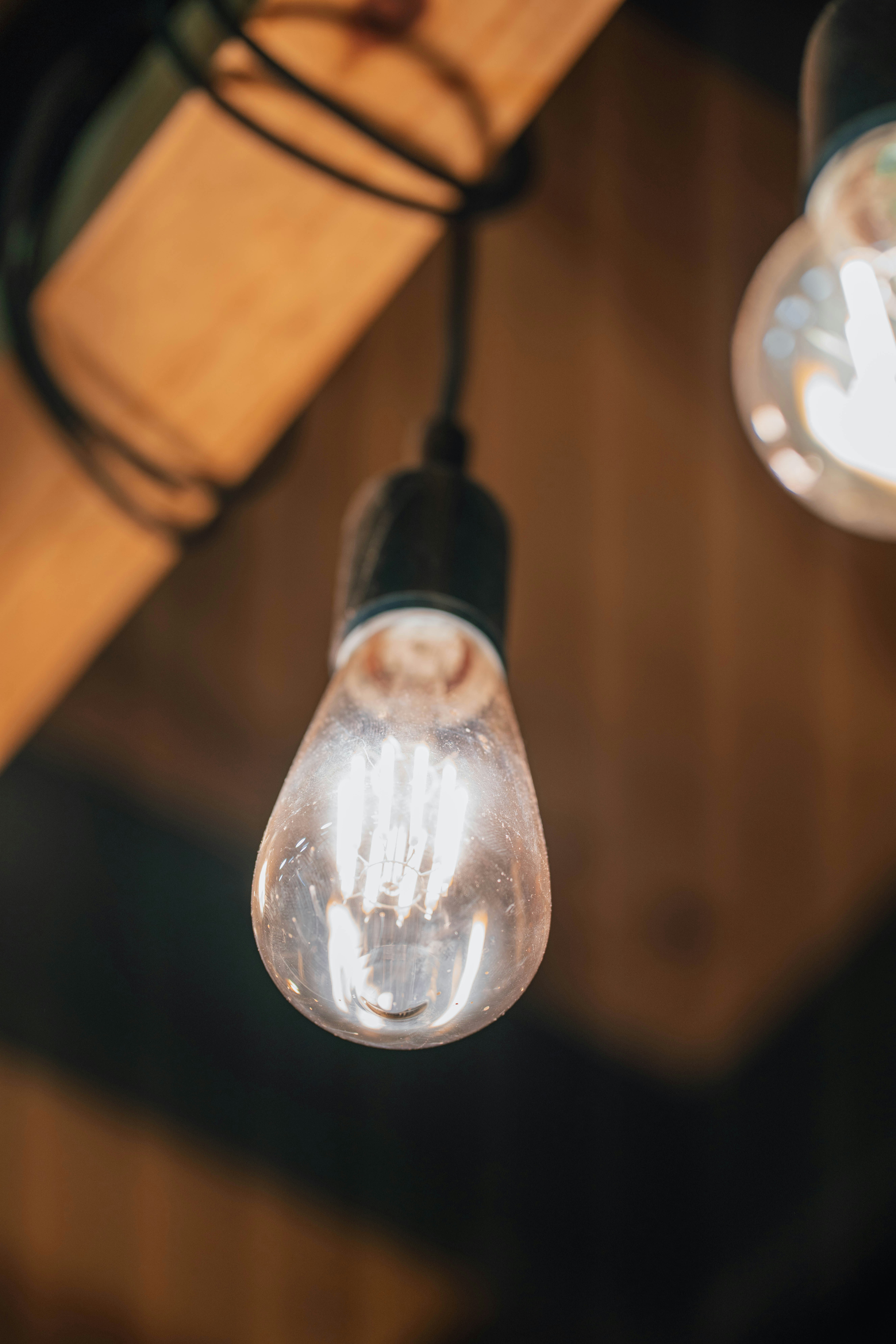 A couple of light bulbs hanging from a ceiling photo – Free Light Image ...