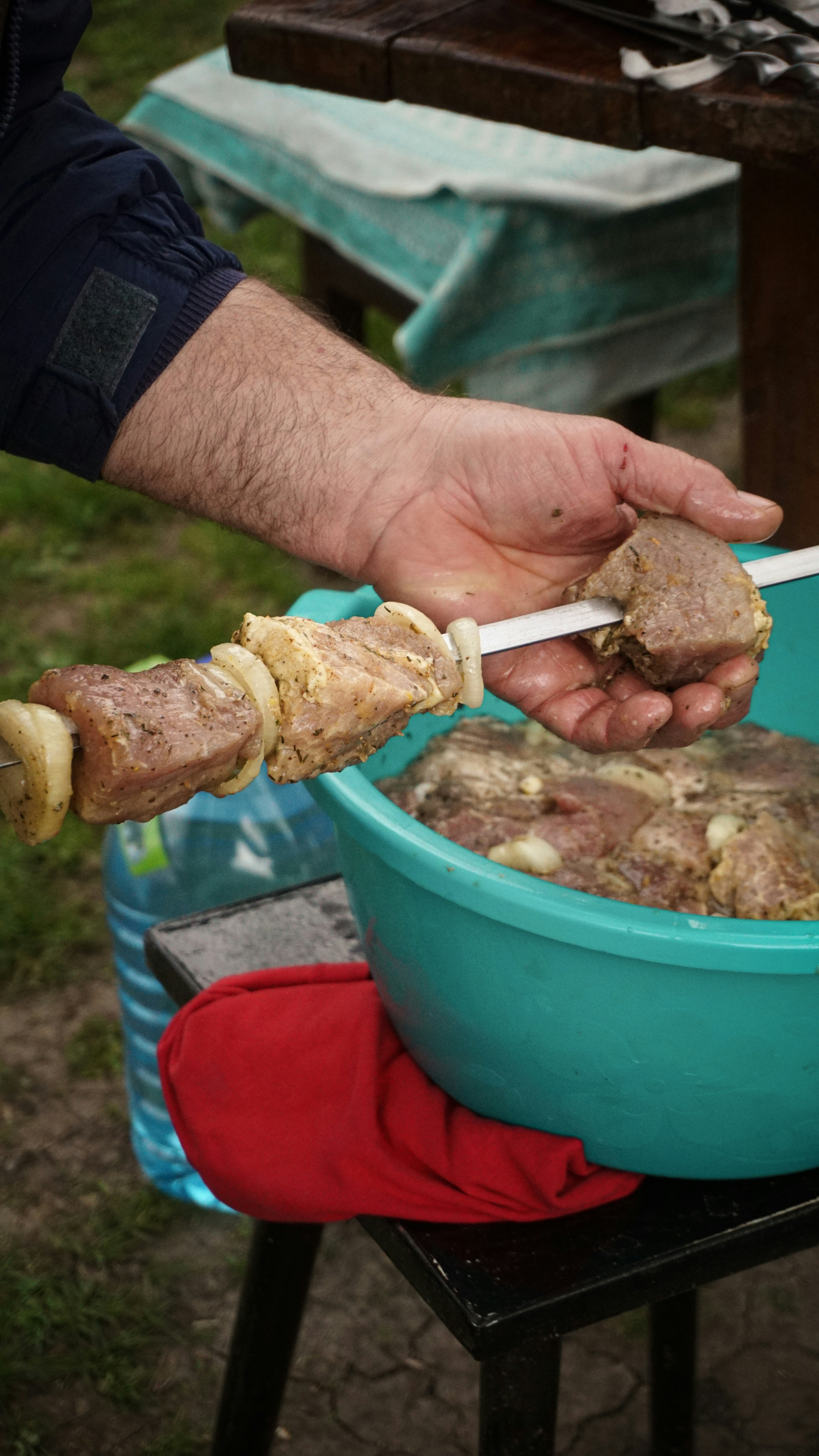 A person is holding a stick over a bowl of food photo – Free Home ...