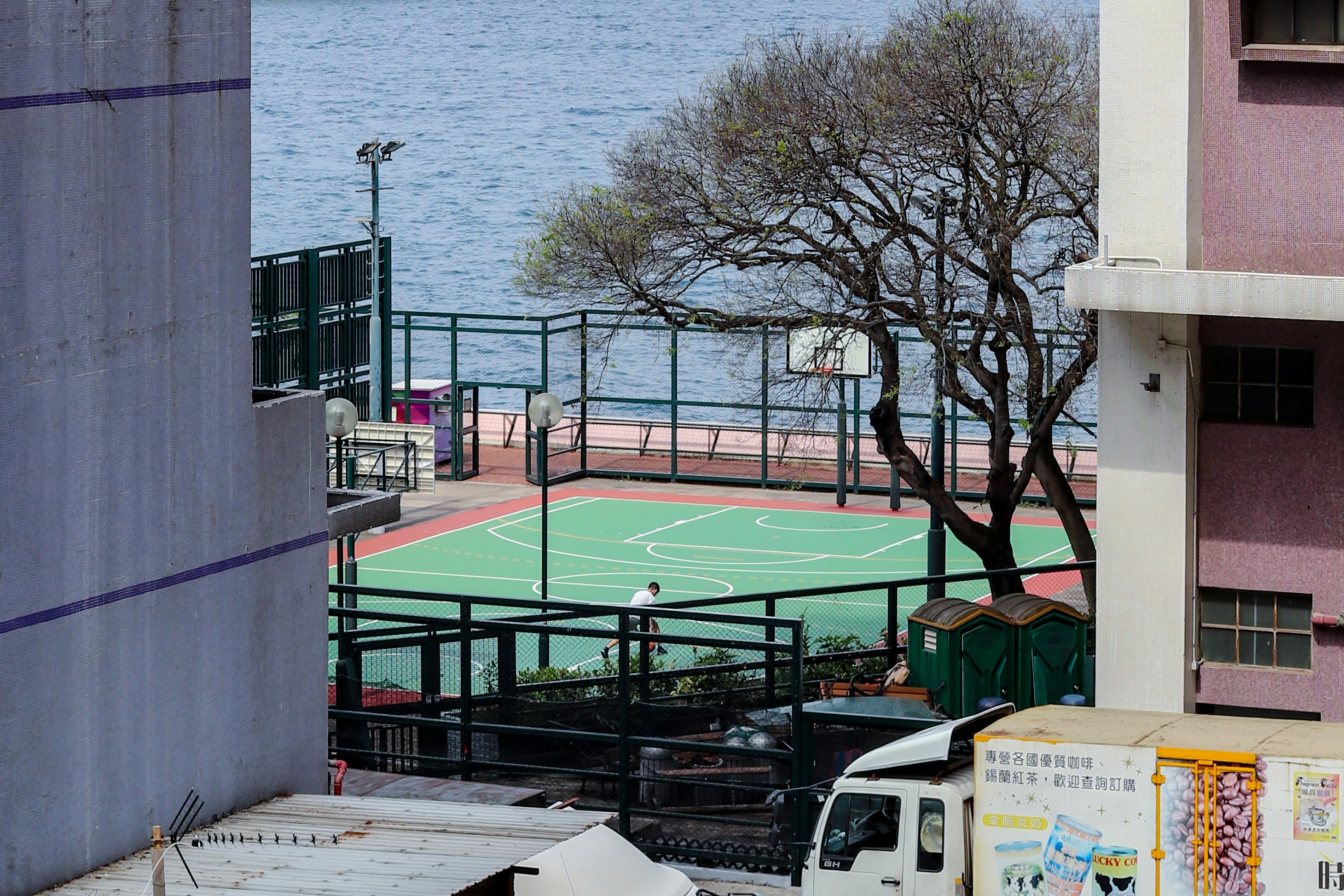 a truck parked in front of a basketball court