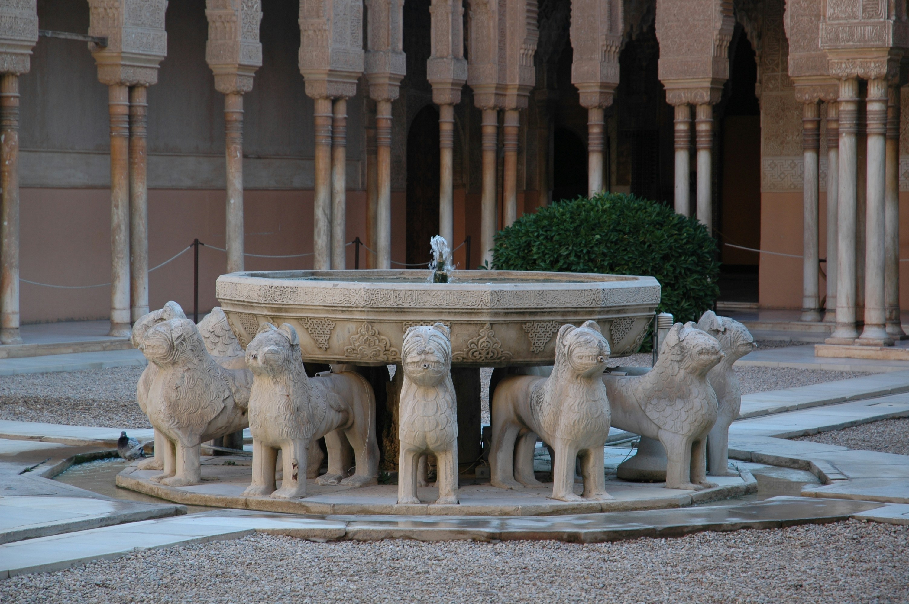 a fountain with four statues of animals around it