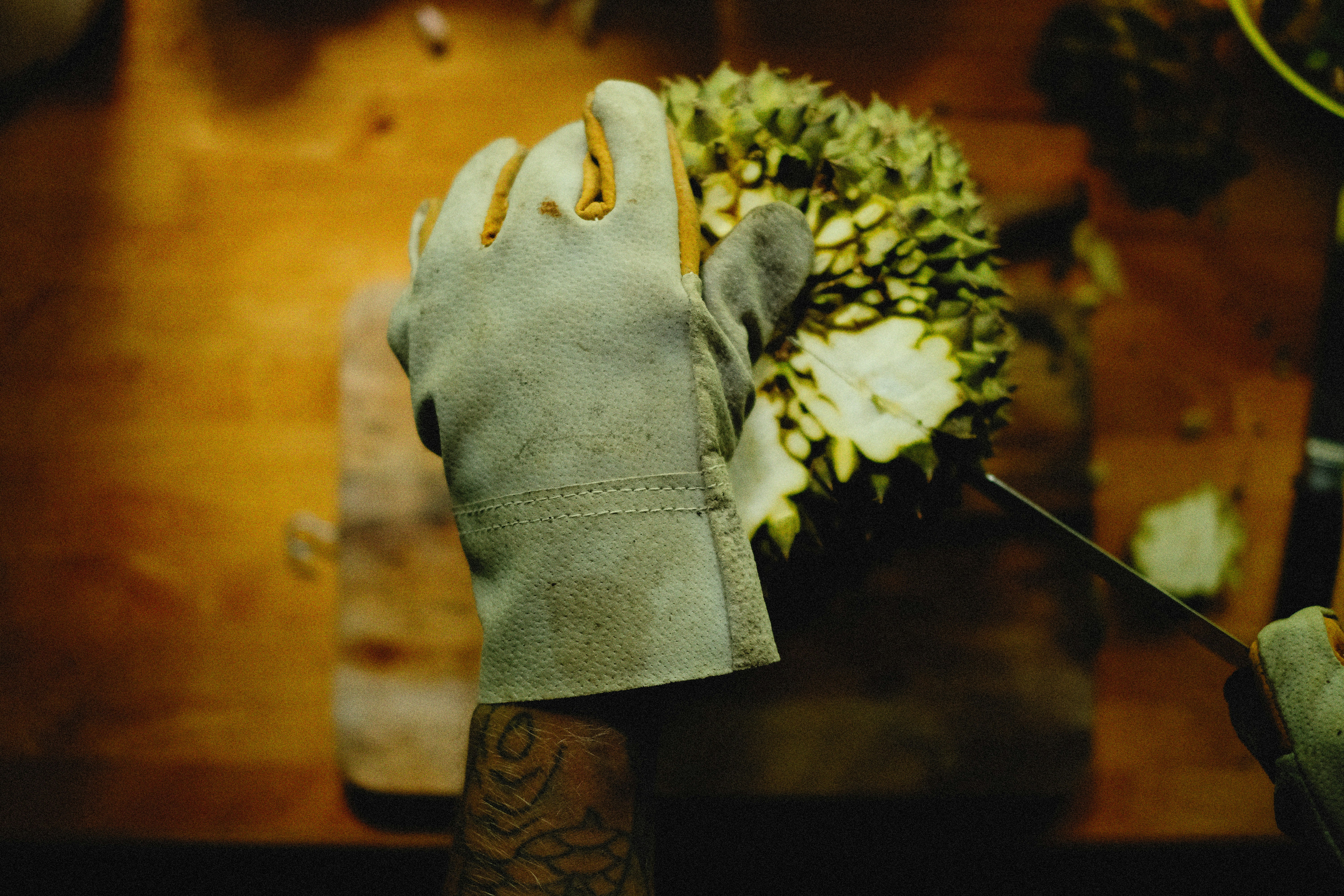 Gloved Hands at Work: Crafting with a Knife and Wild Fruit