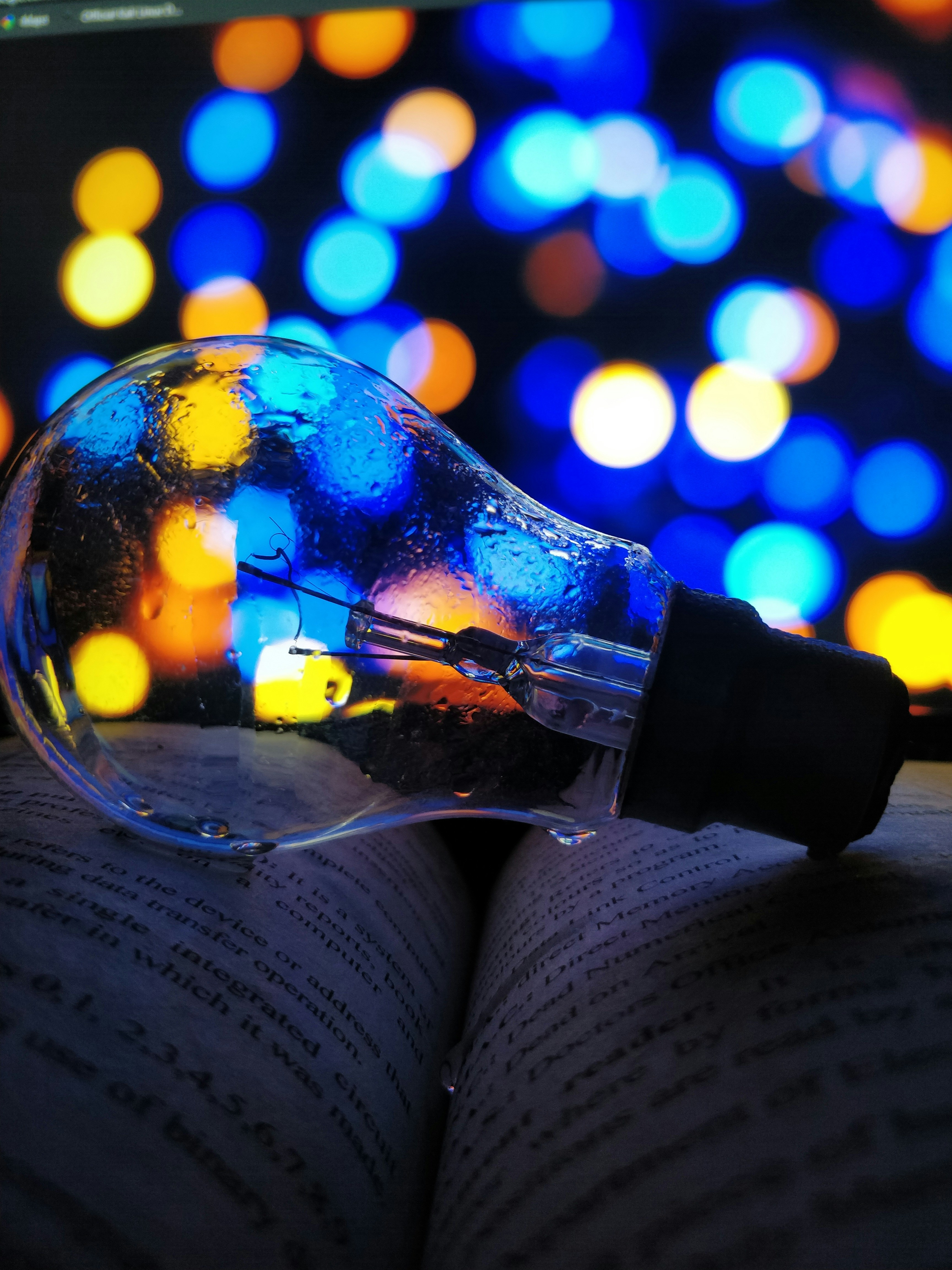 Prismatic Quiet: Glass Bulb Framed by Ink and Neon Bokeh
