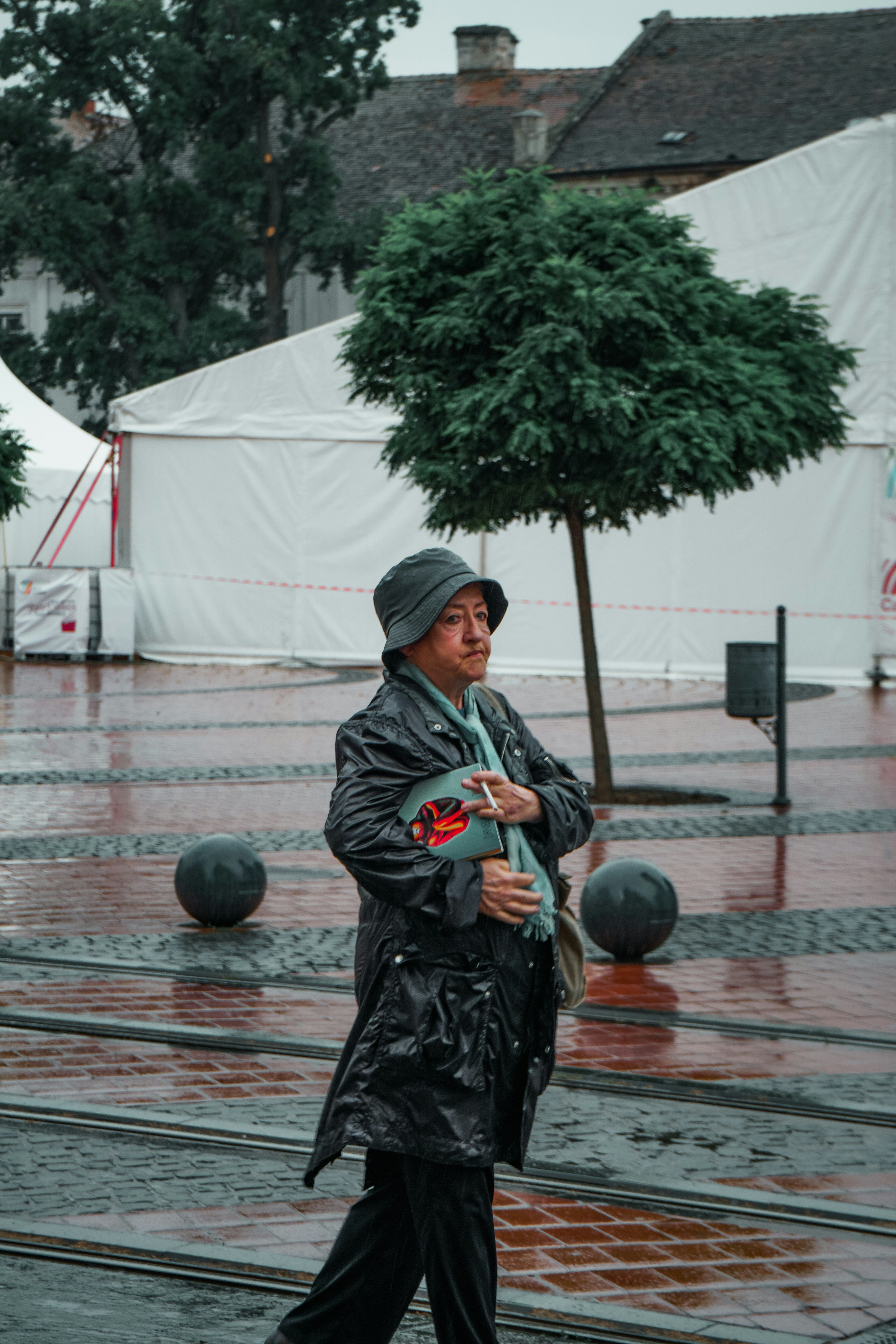 Rain-Washed Portrait in a White-Tented City Square