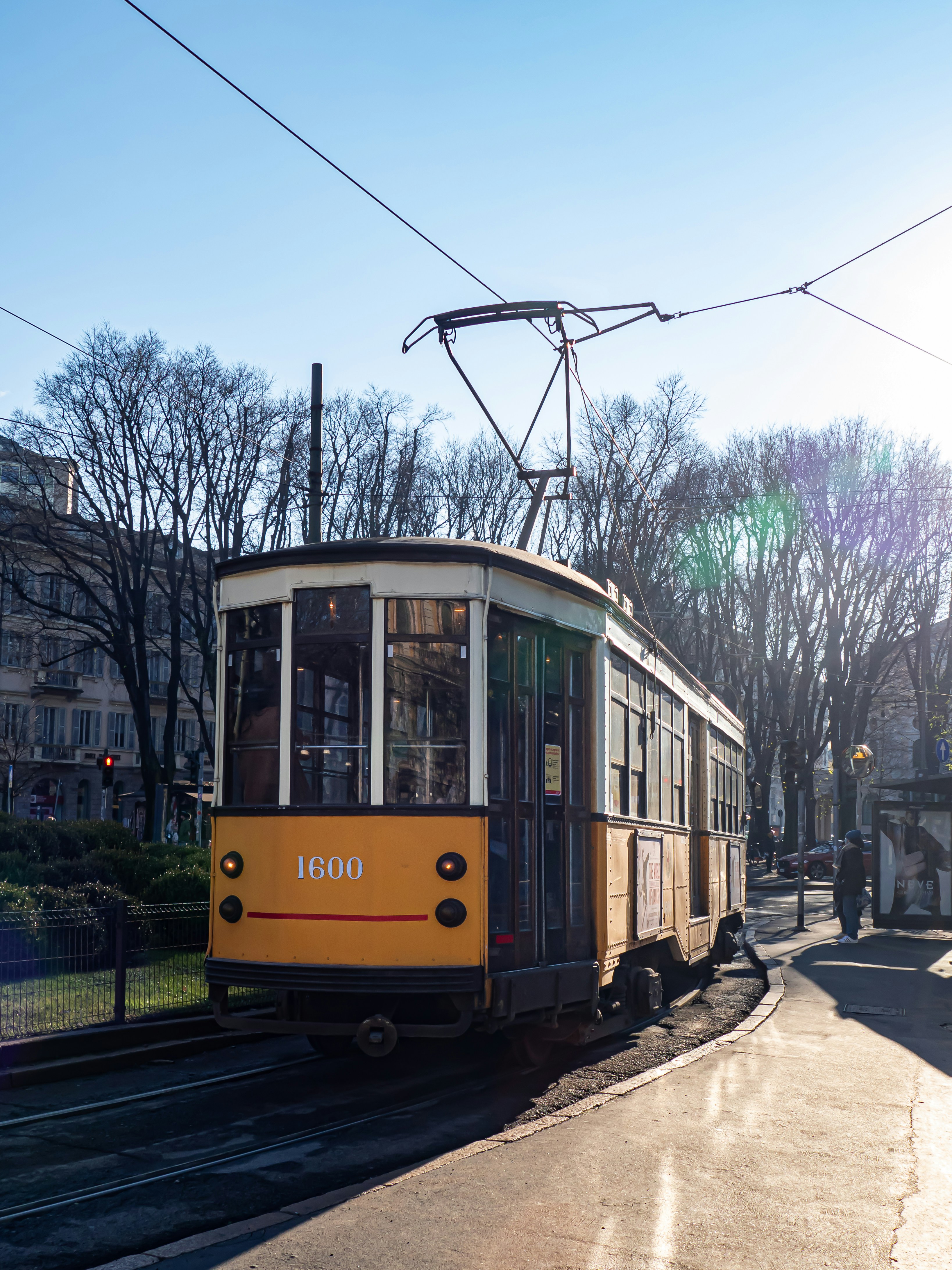Sunlit 1600 Tram on a Quiet City Street