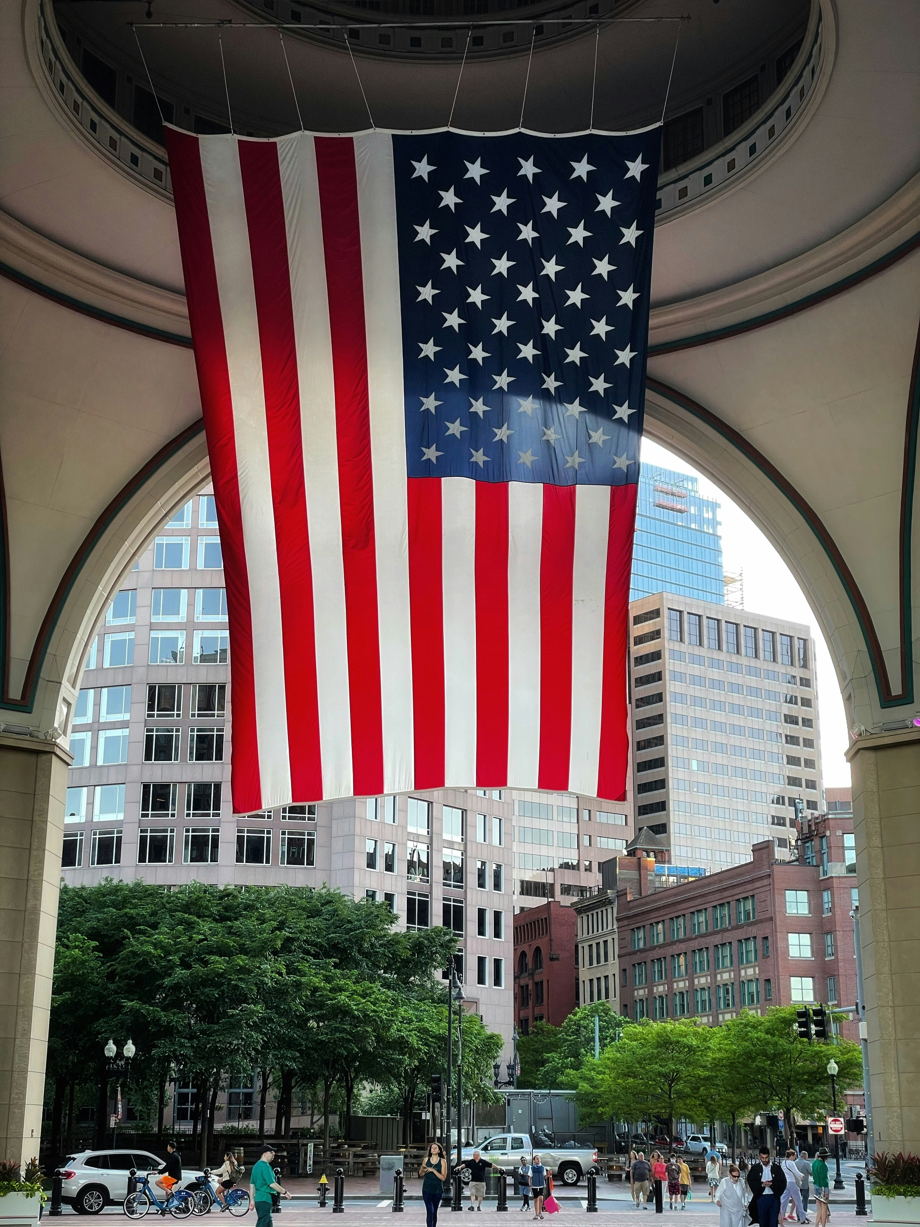 Flag Over Archway: Urban Monument Framed by Glass and Sky