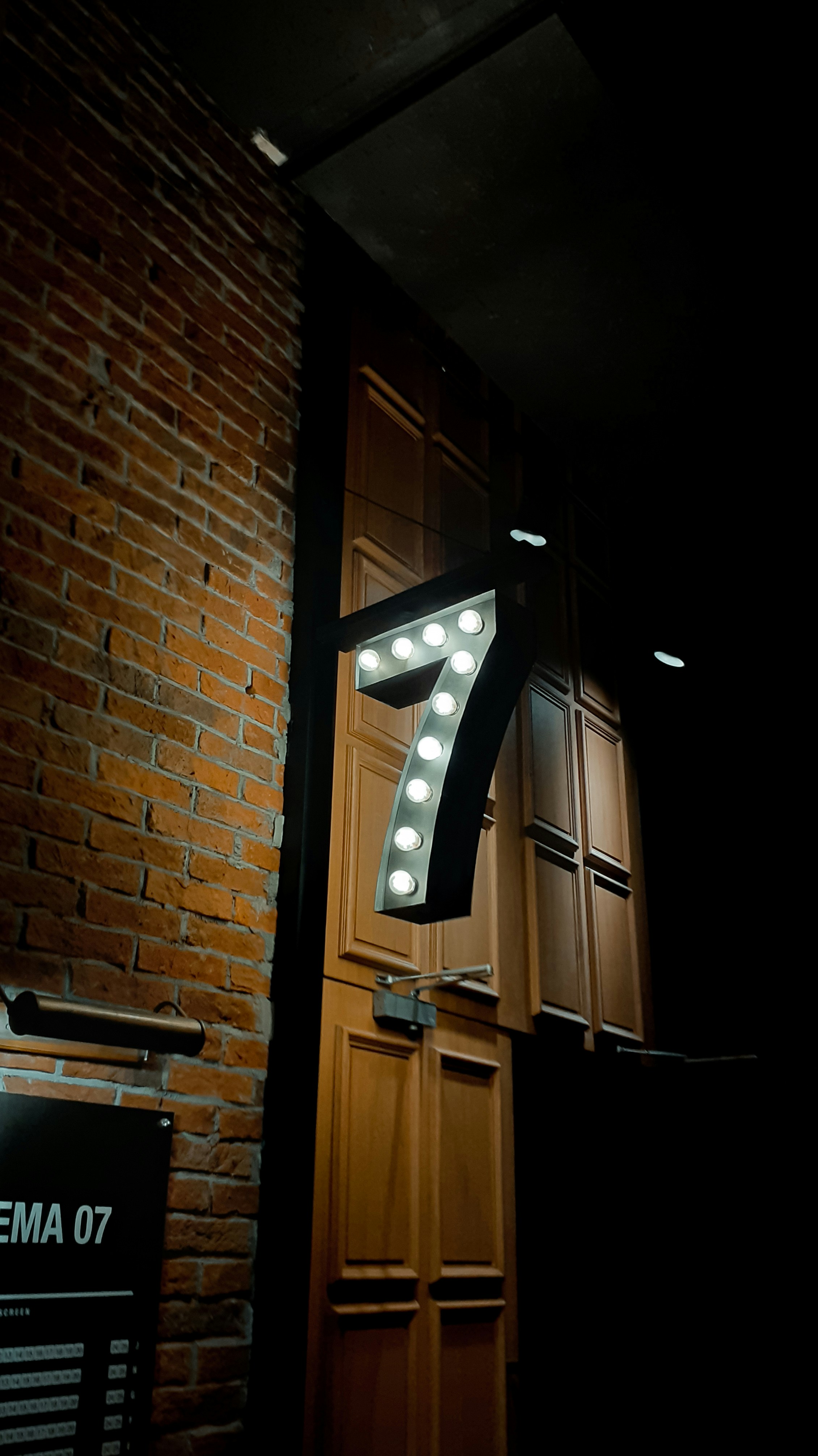 A sign that is on the side of a building photo – Free Brick Image on ...