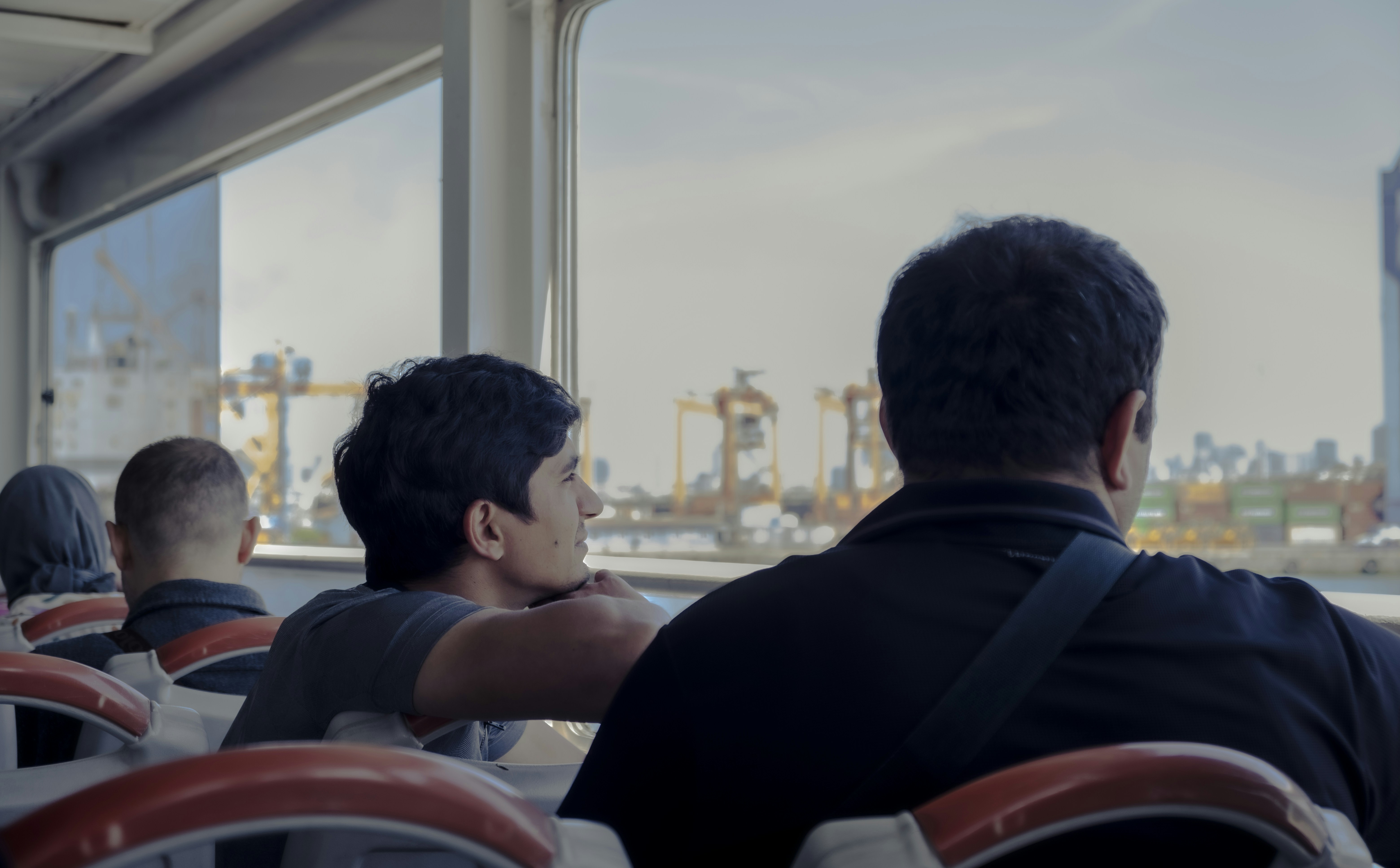 Cranes and Commuters: A Harbor View Through Bus Windows