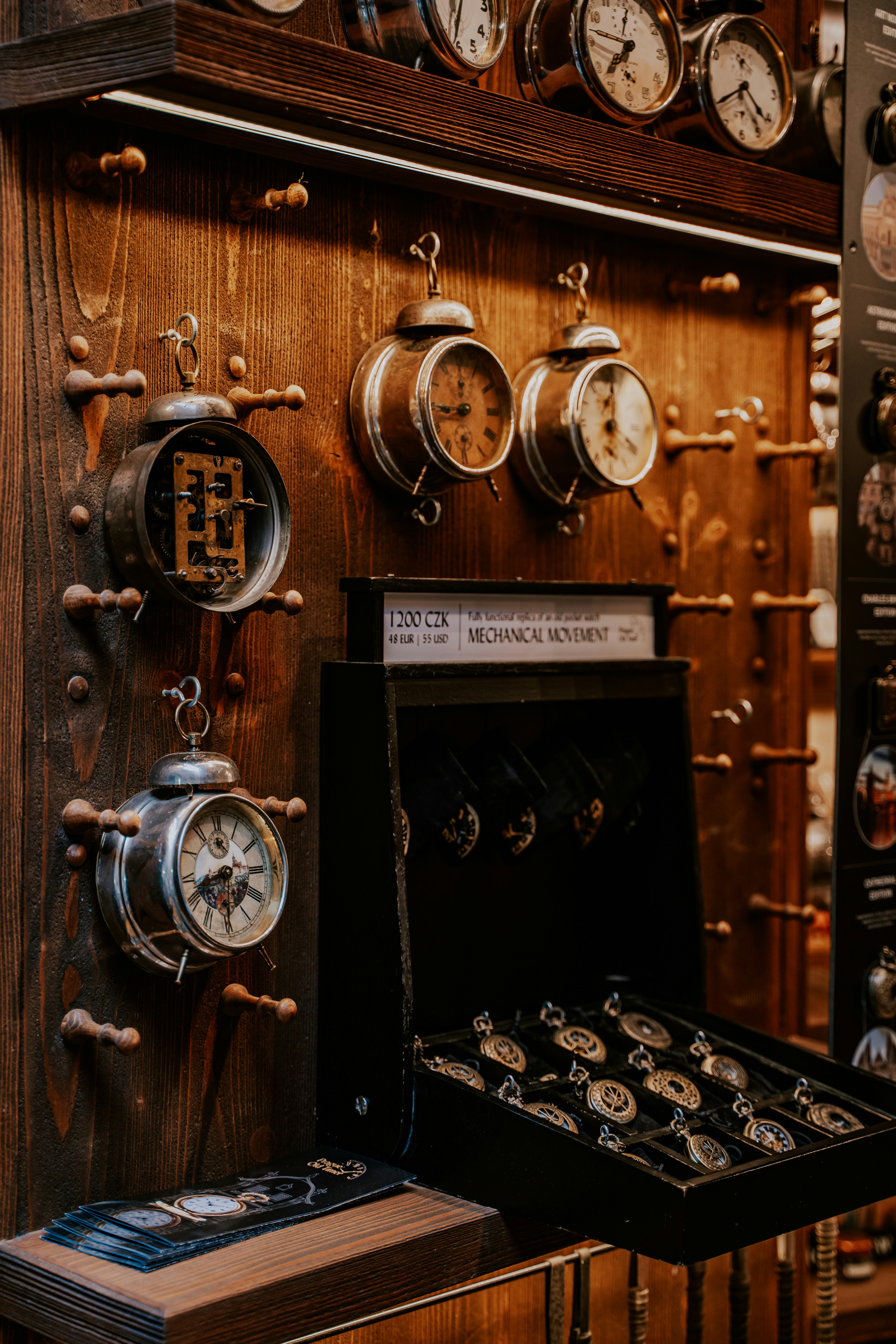 A bunch of clocks that are on a wall photo – Free Brown Image on Unsplash